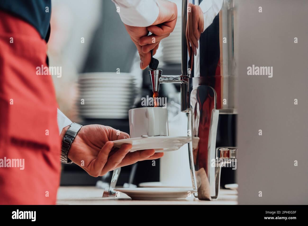 The waiter preparing coffee for hotel guests. Close up photo of service ...