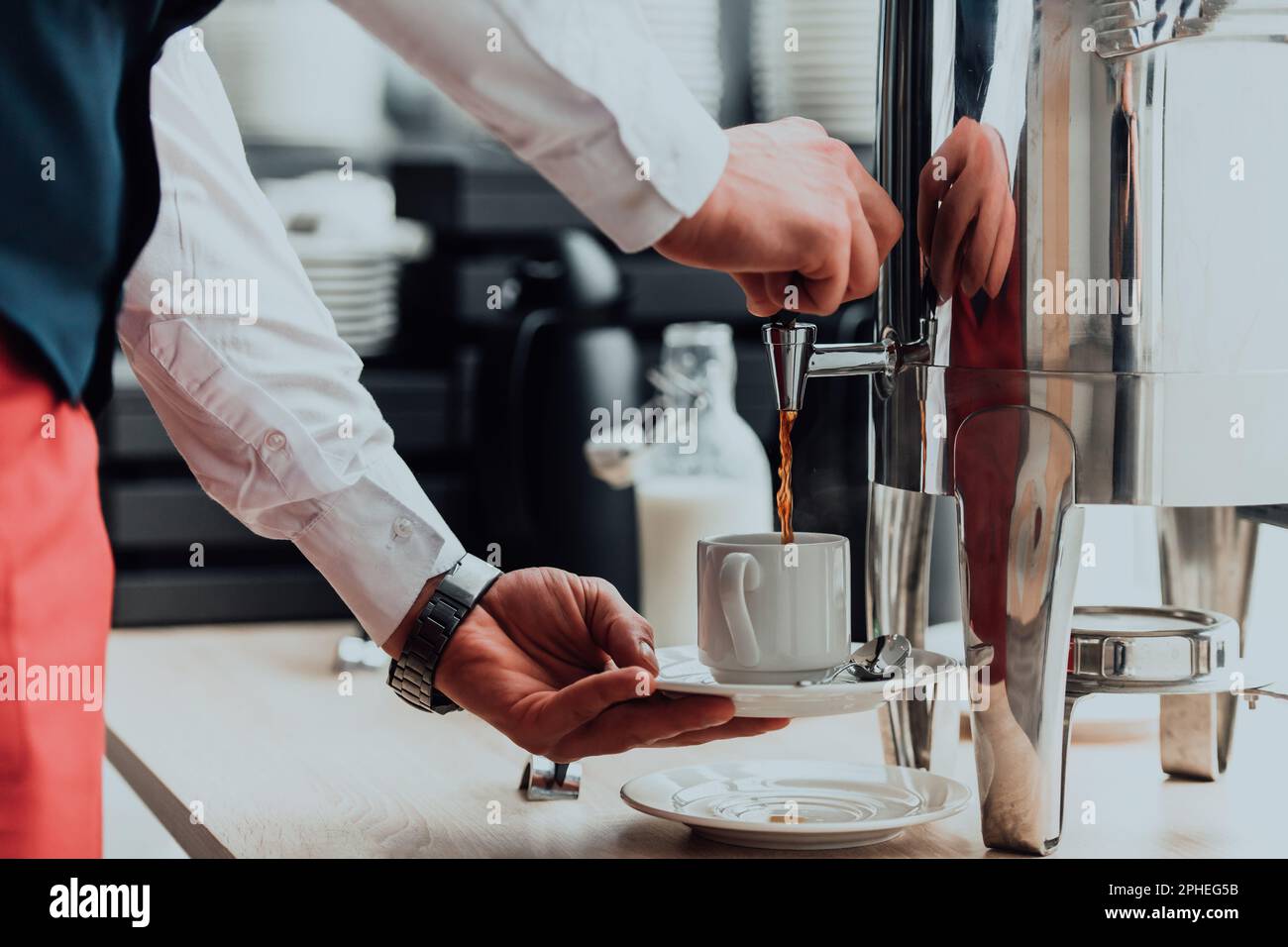 The waiter preparing coffee for hotel guests. Close up photo of service ...