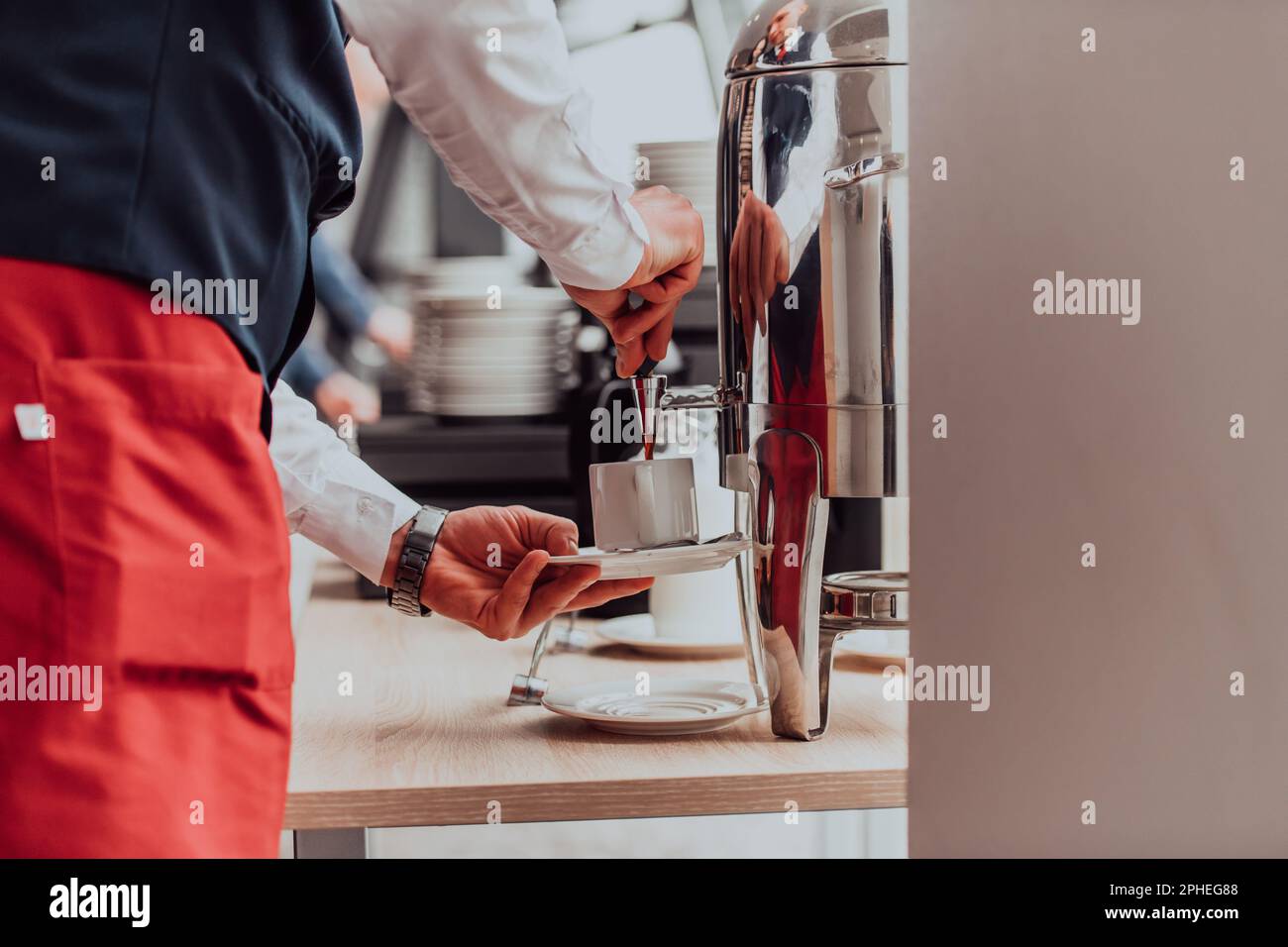 The waiter preparing coffee for hotel guests. Close up photo of service ...