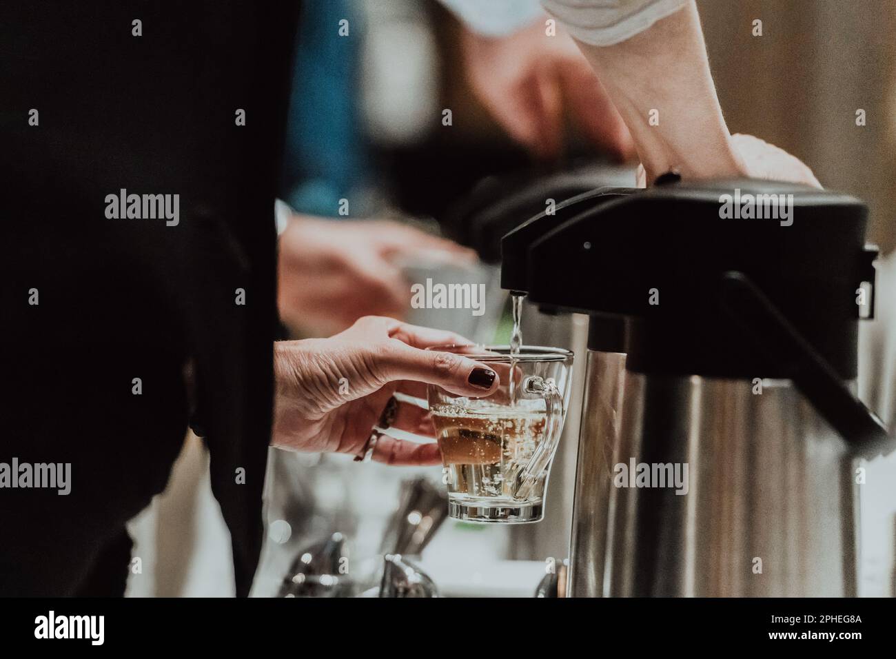 The waiter preparing coffee for hotel guests. Close up photo of service ...