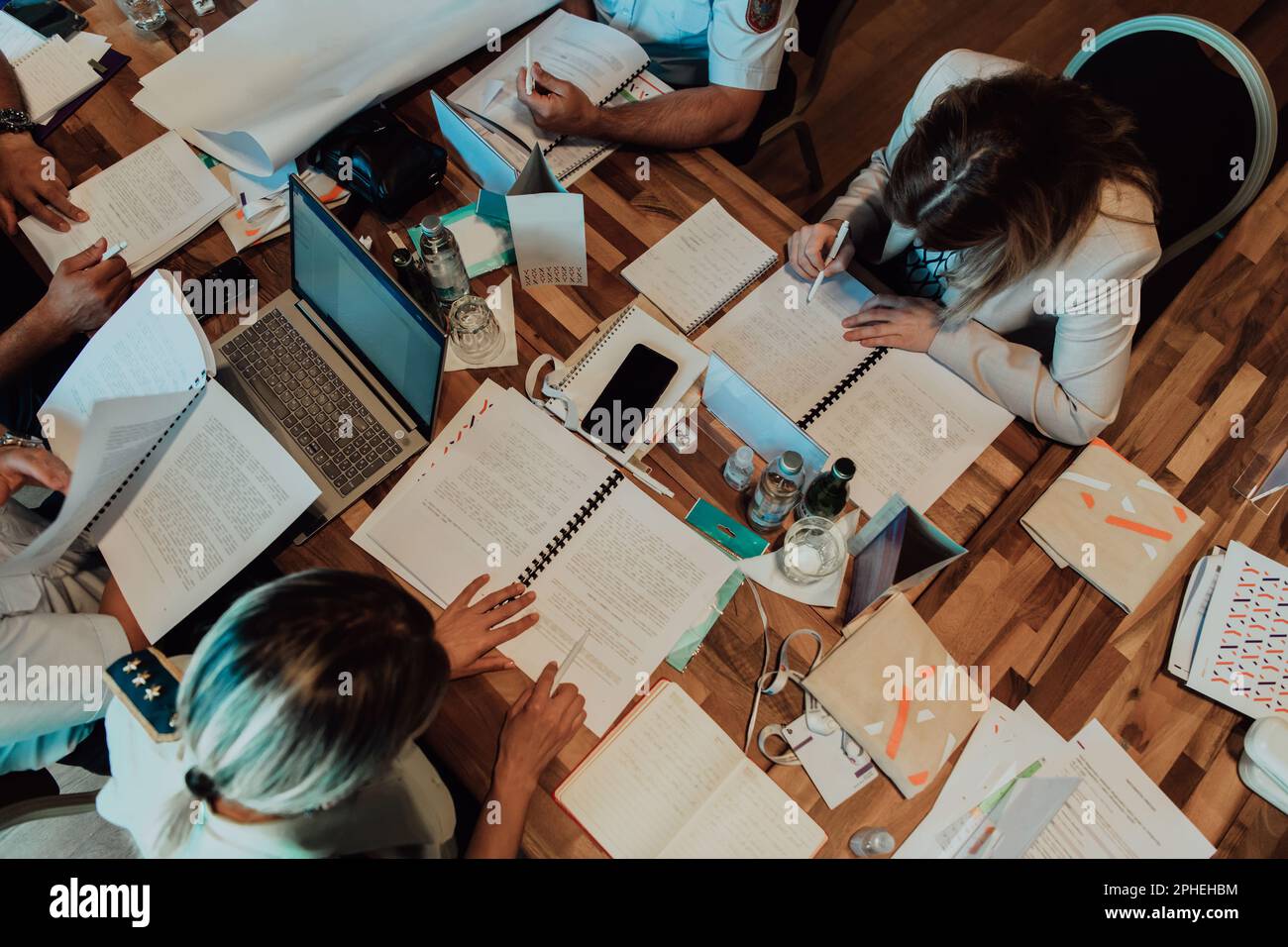 Top view of colleagues sorting out paperwork together. Businessman ...