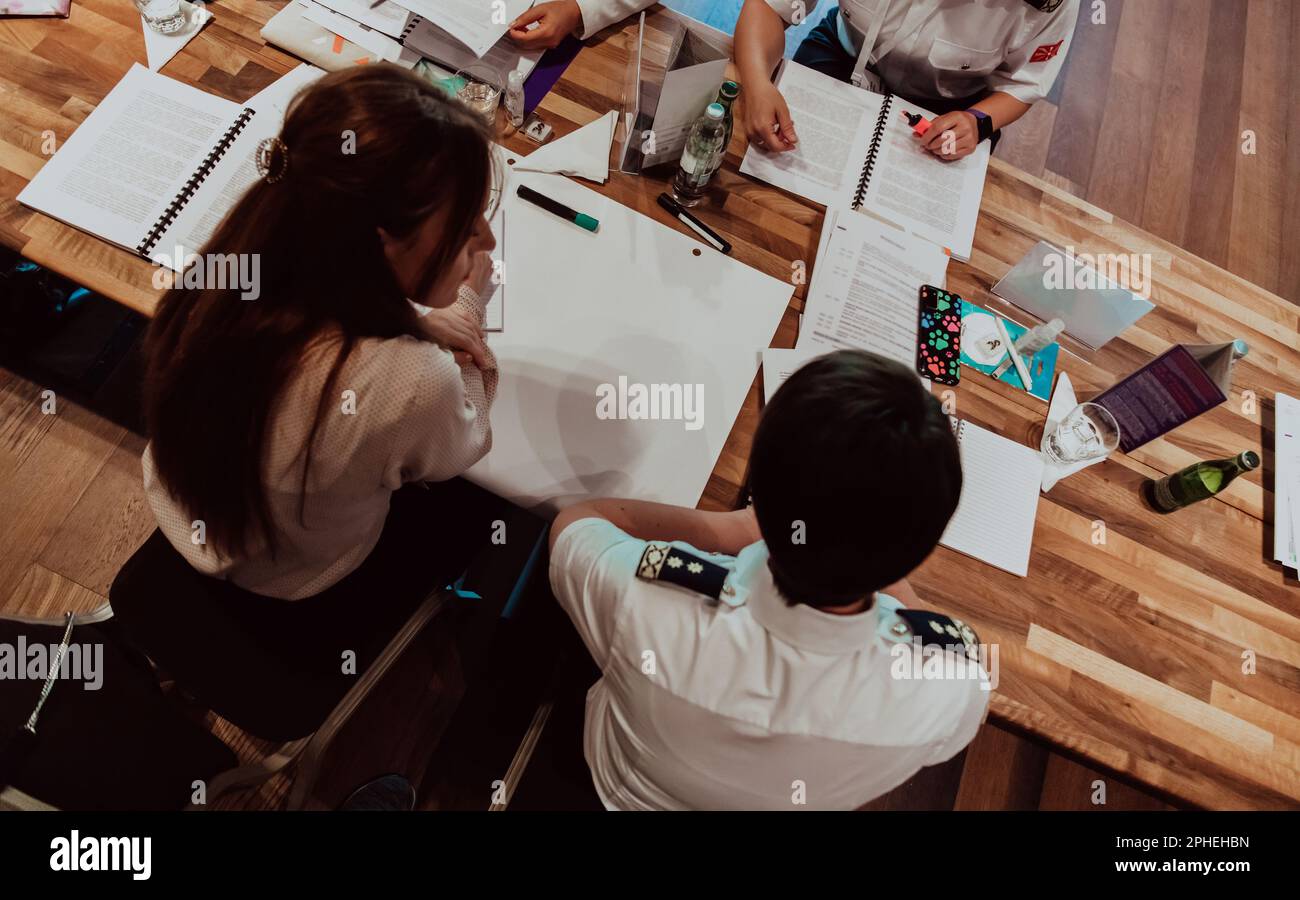 Top view of colleagues sorting out paperwork together. Businessman ...