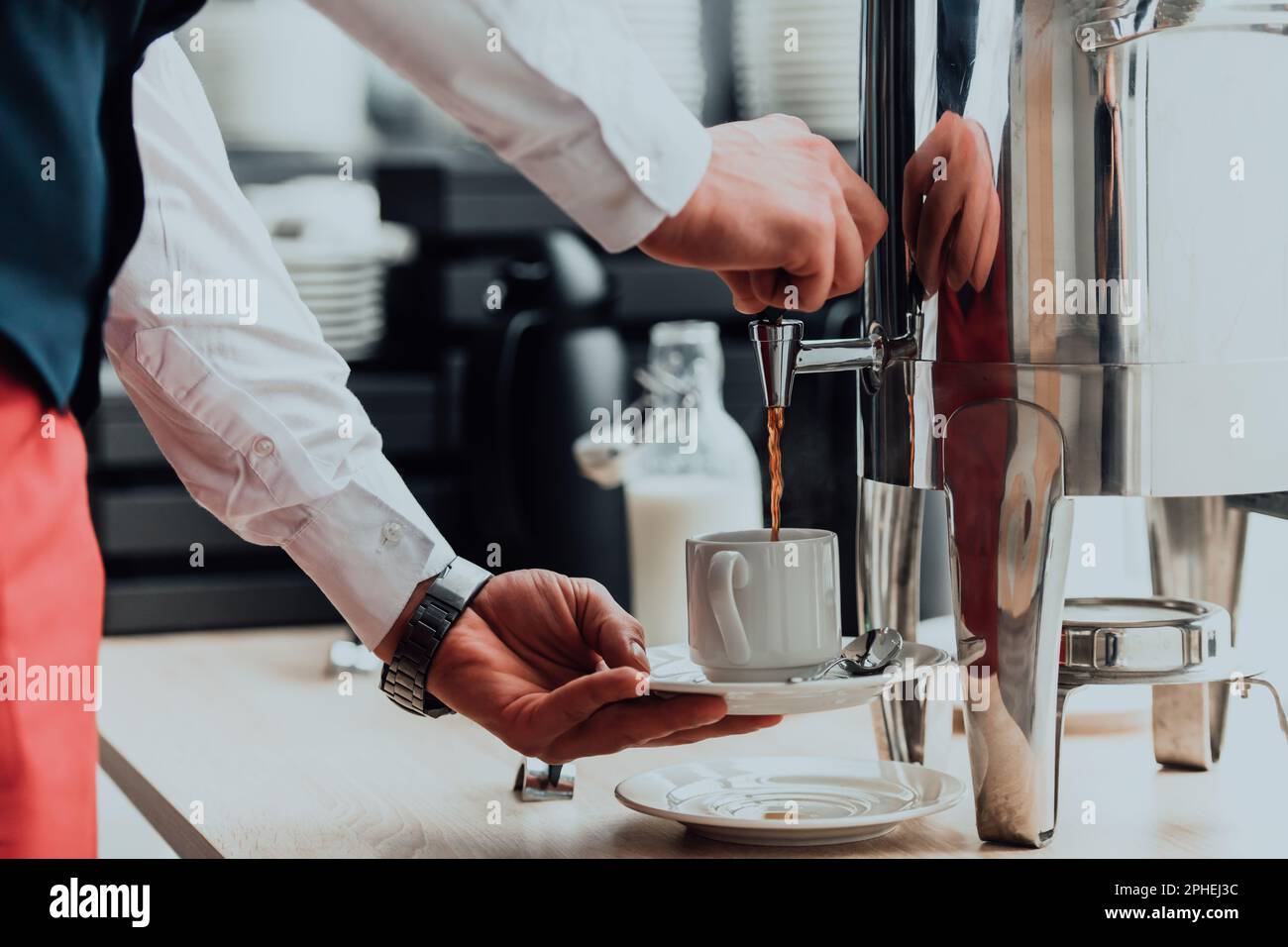 The waiter preparing coffee for hotel guests. Close up photo of service ...