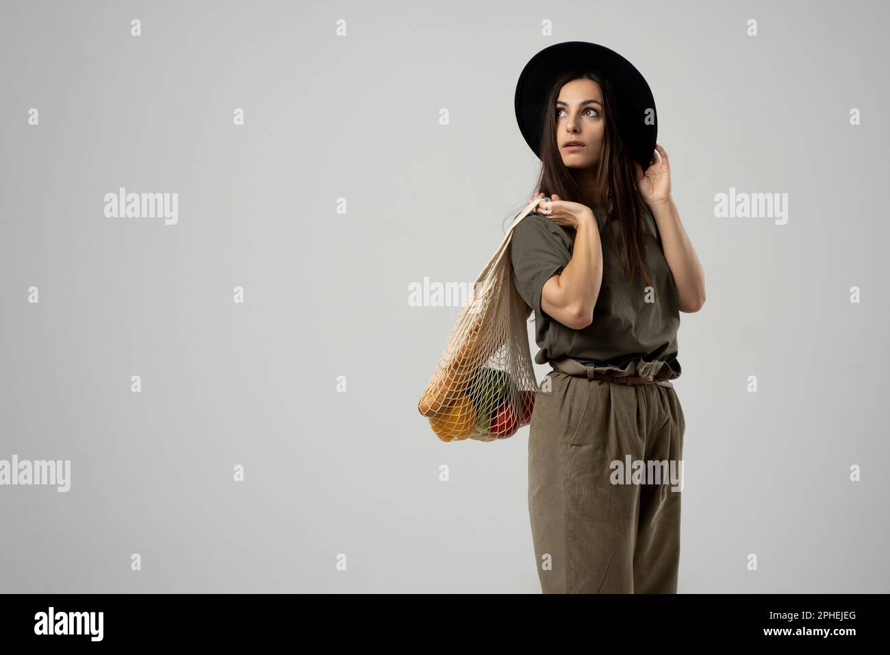 Zero waste concept. A young girl holds on her shoulder a textile mesh ...
