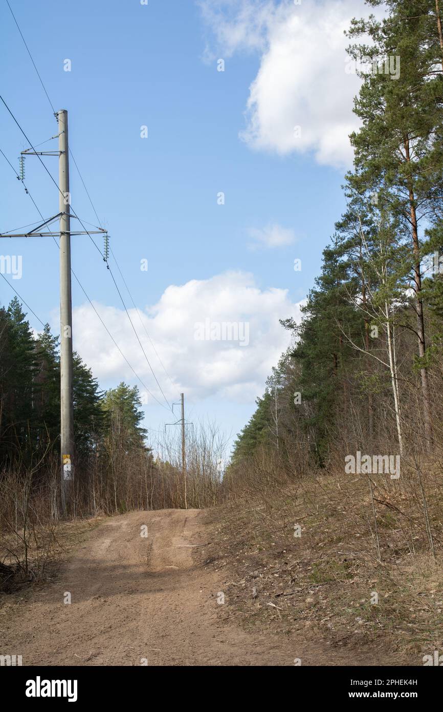 photo of power poles by voltage in the forest Stock Photo - Alamy