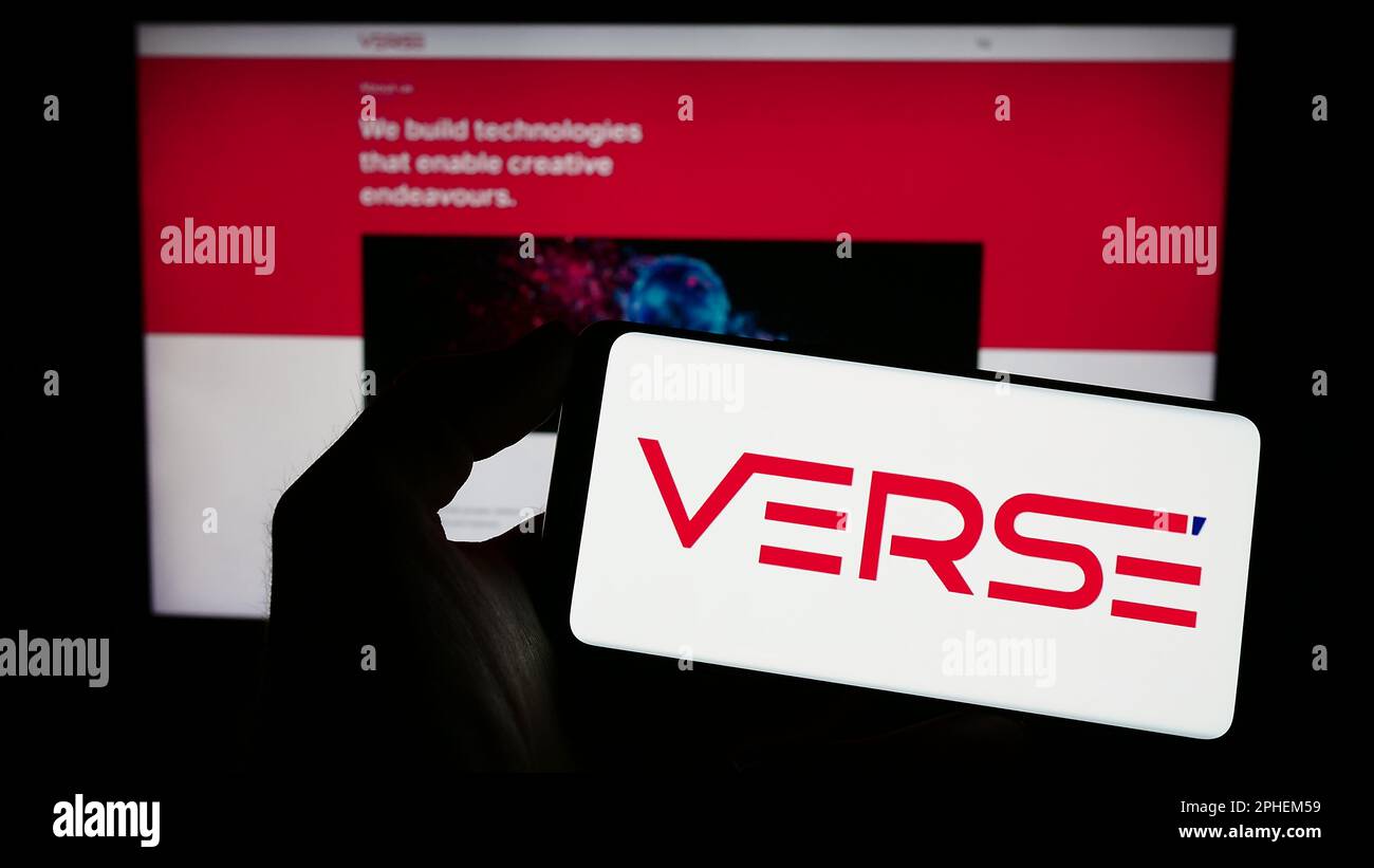 Person holding mobile phone with logo of Indian company VerSe ...