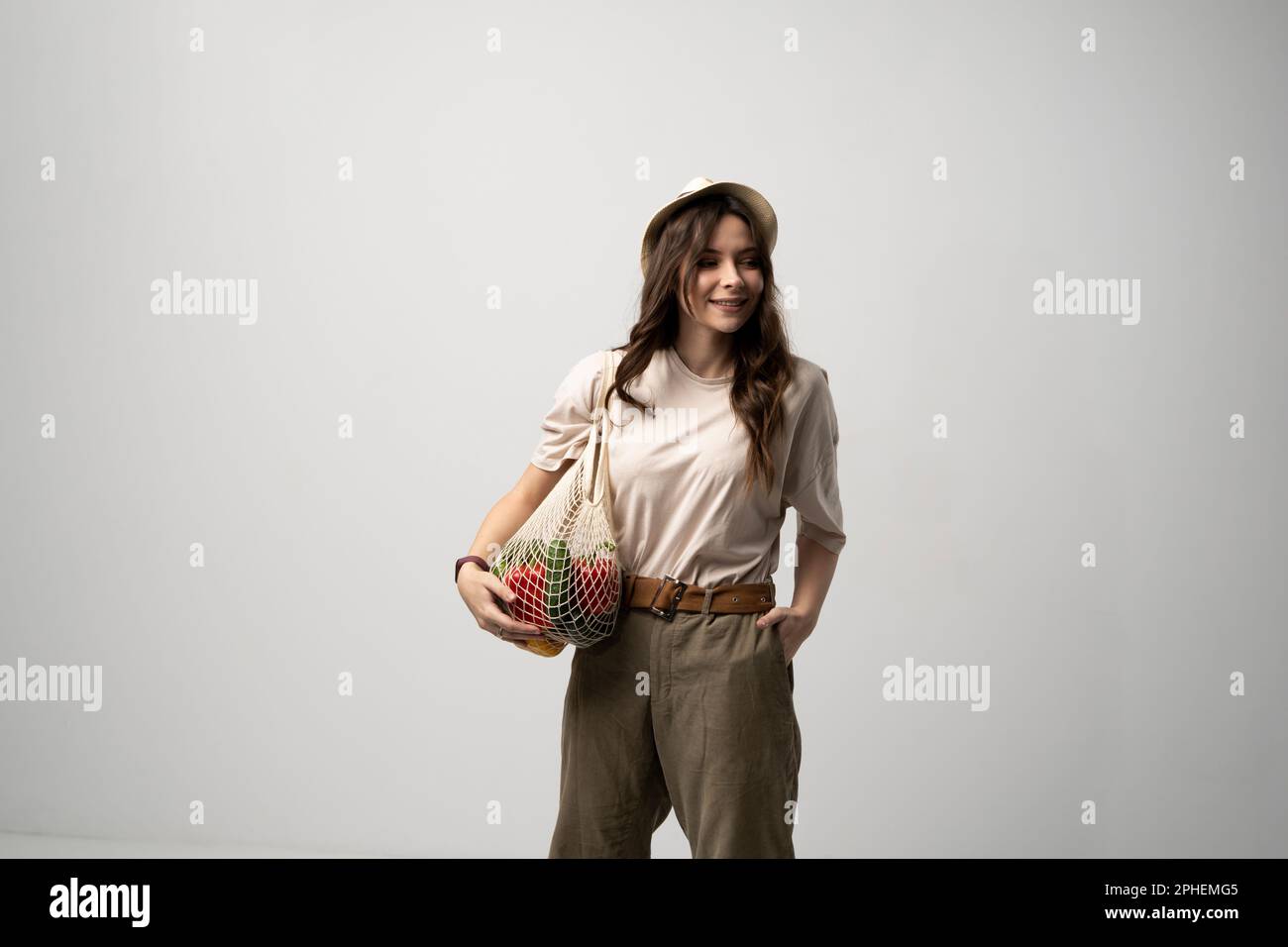 Zero waste concept. A young girl holds on her shoulder a textile mesh ...