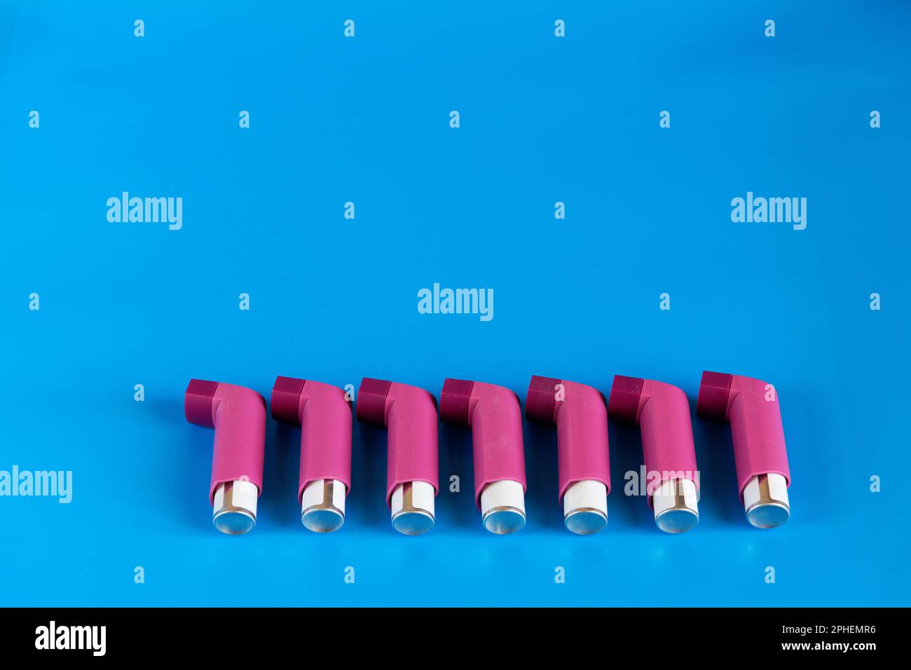 Asthma inhalers in a row on a blue background with a copy space Stock ...