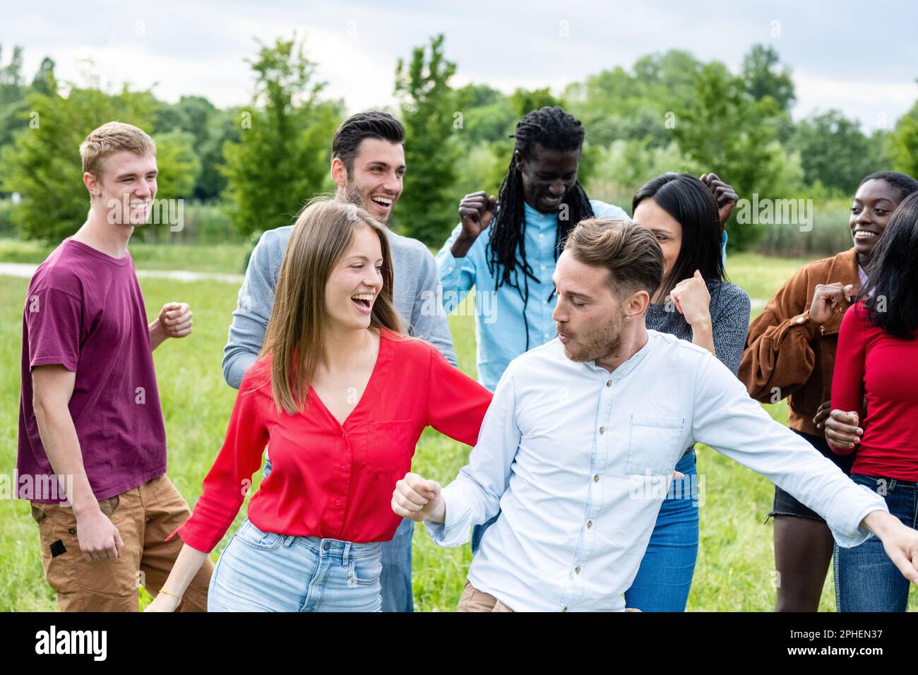 Group of best friends and young couples having fun outside dancing and ...