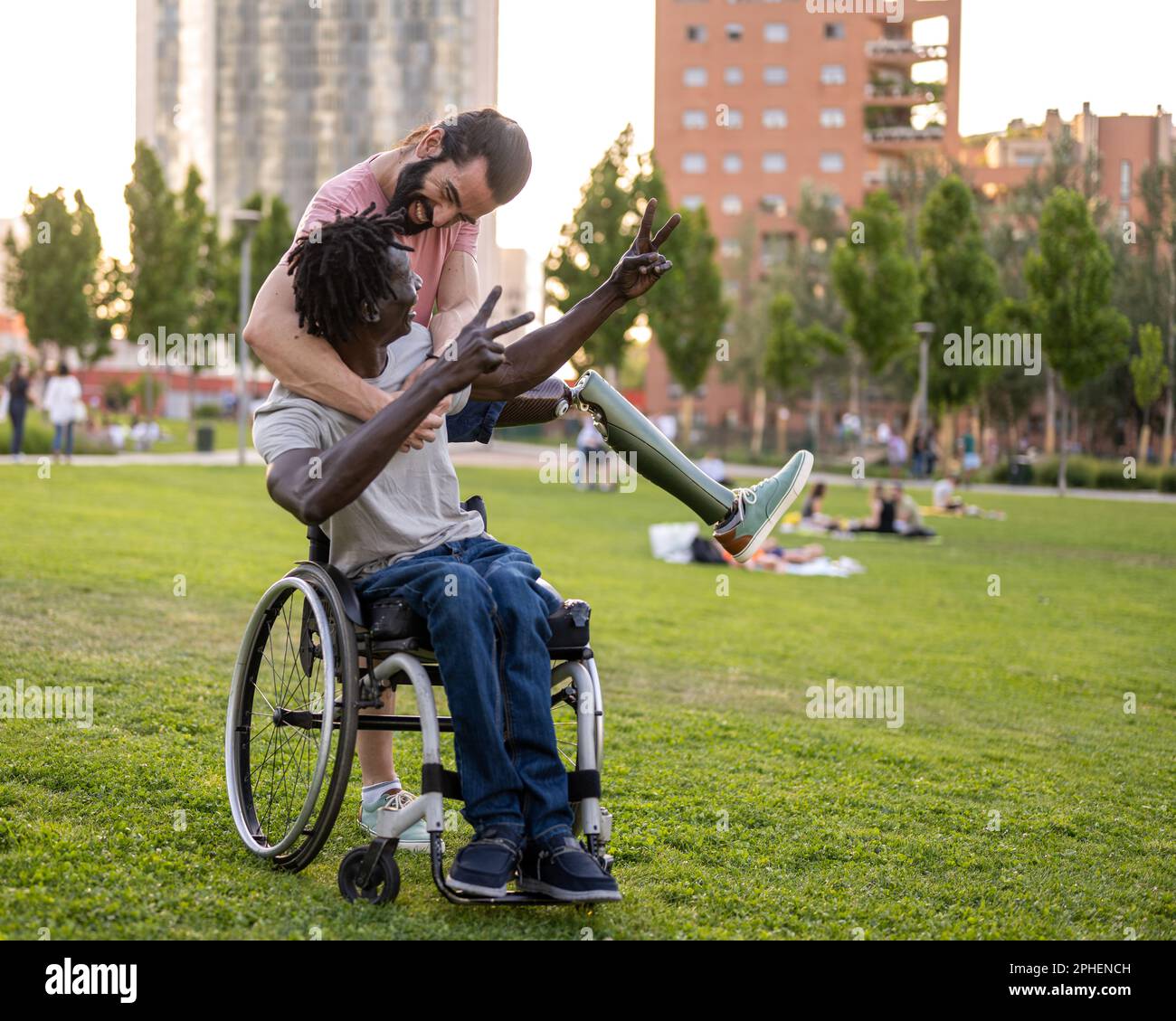 People with different disabilities joke outdoors in the city park ...