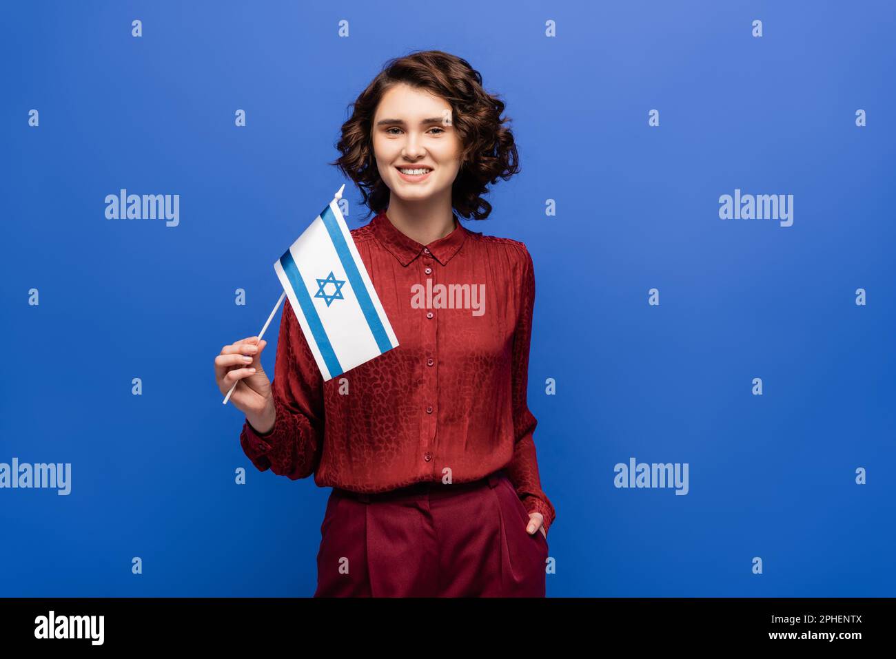 happy teacher of Hebrew language holding flag of Israel isolated on ...