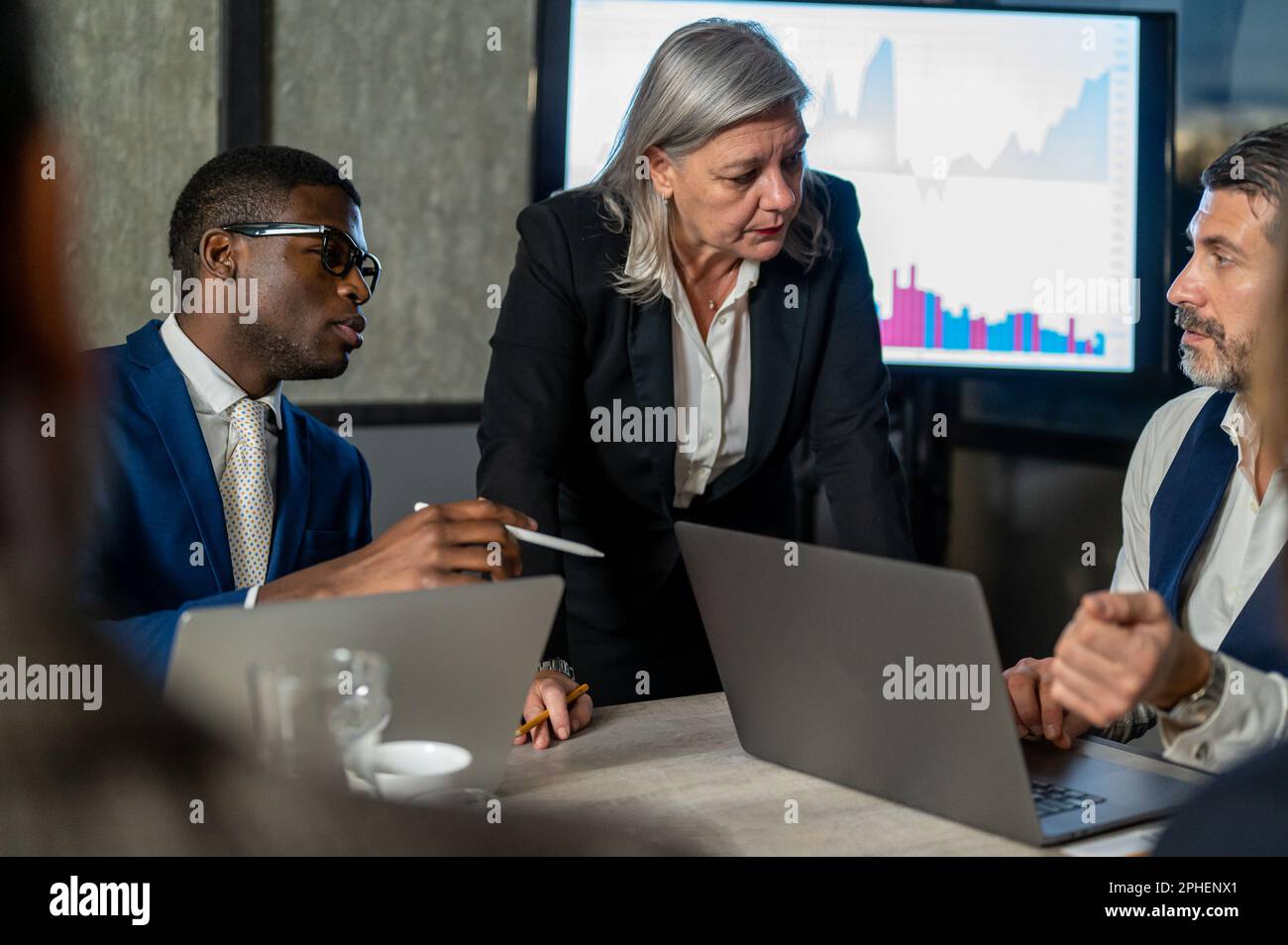 Thoughtful senior business woman concentrated on collaboration with ...