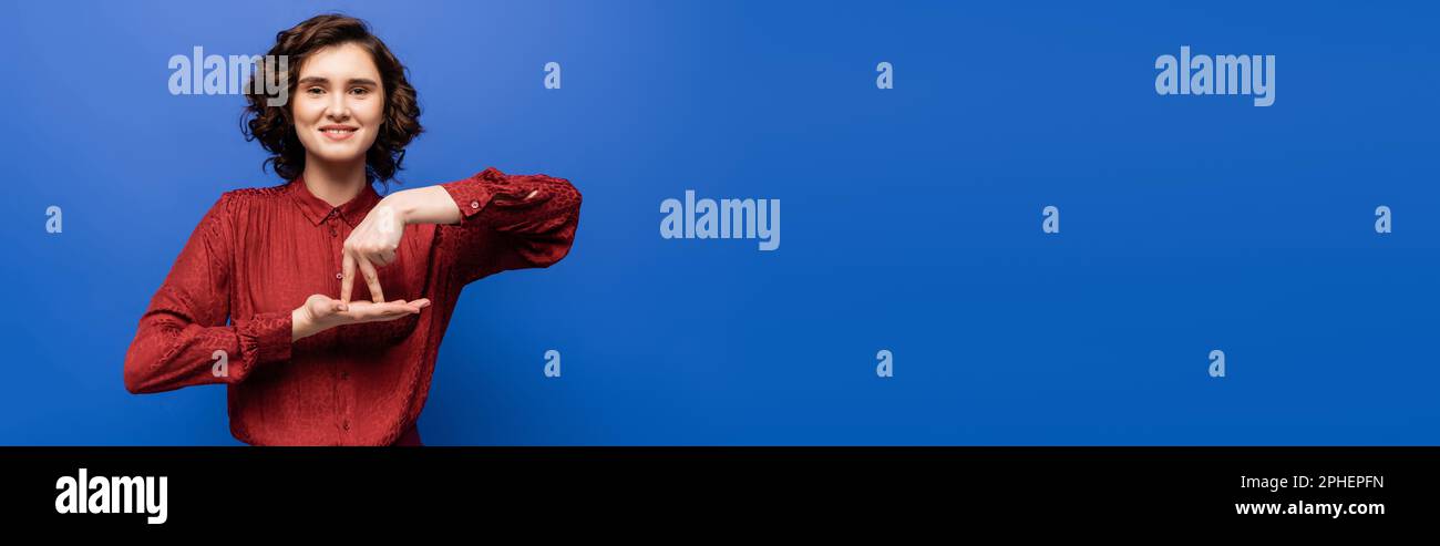 happy young woman showing symbol meaning stand on sign language ...