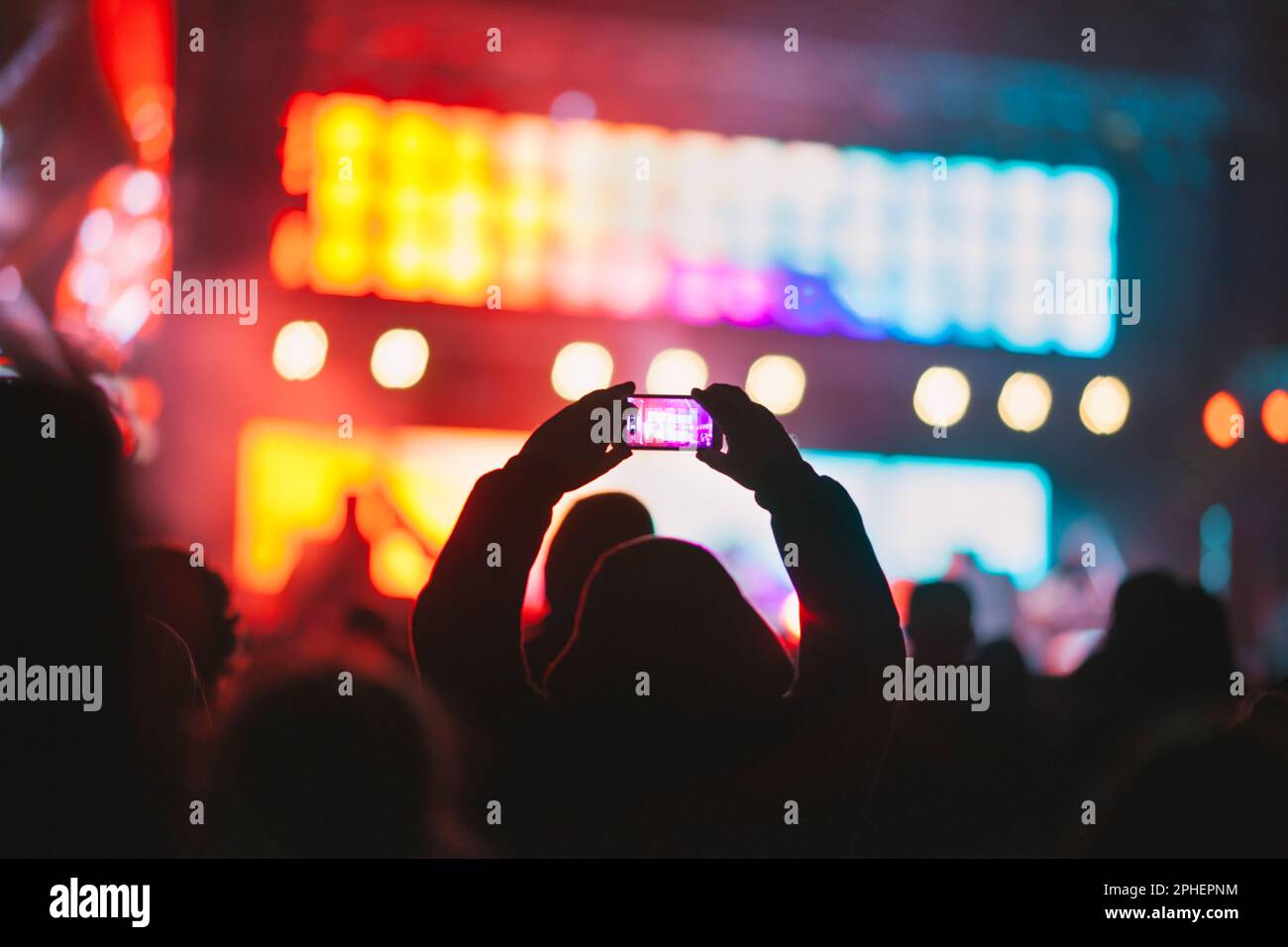 Back view silhouette of unrecognizable person taking video with ...