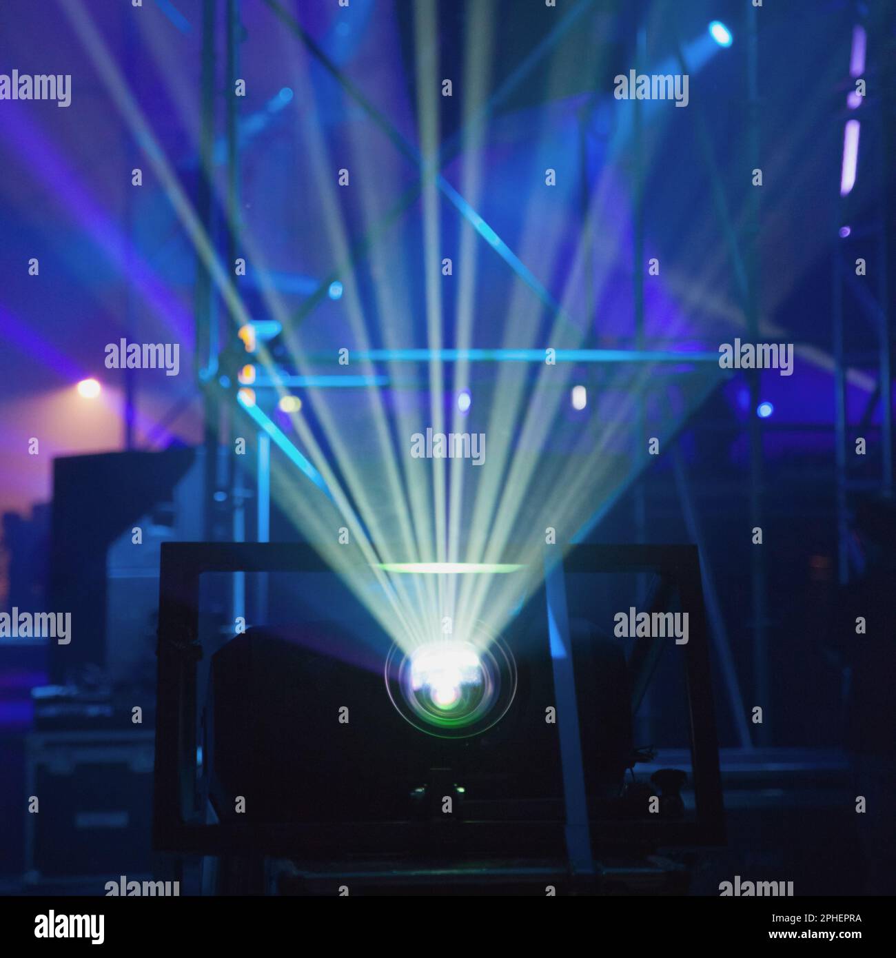 Colorful beams of bright laser light illuminating music venue during ...
