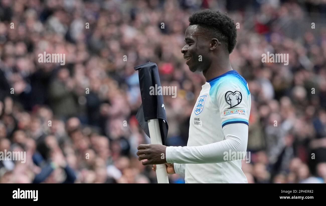 England's Bukayo Saka knock over the corner flag as he celebrates after ...