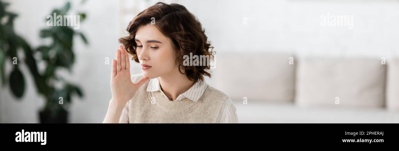 brunette curly woman showing symbol meaning mother on sign language ...