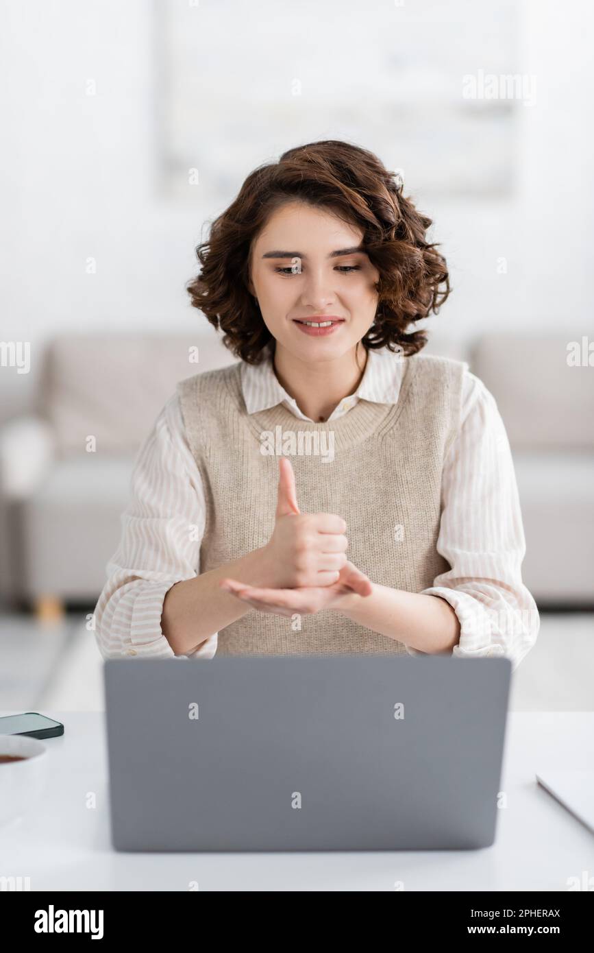 positive teacher with curly hair showing help word on sign language ...