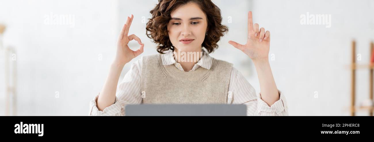 curly sign language teacher showing alphabet letters with hands during ...