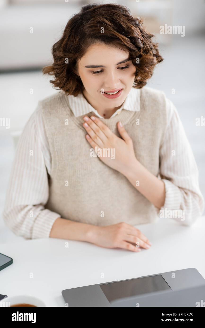 cheerful sign language teacher showing please word during online lesson ...