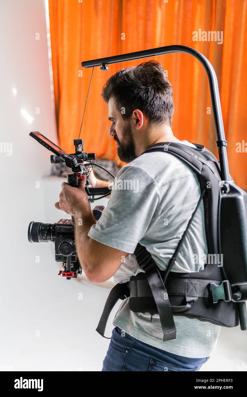 The cameraman in the studio using a professional camera with a ...