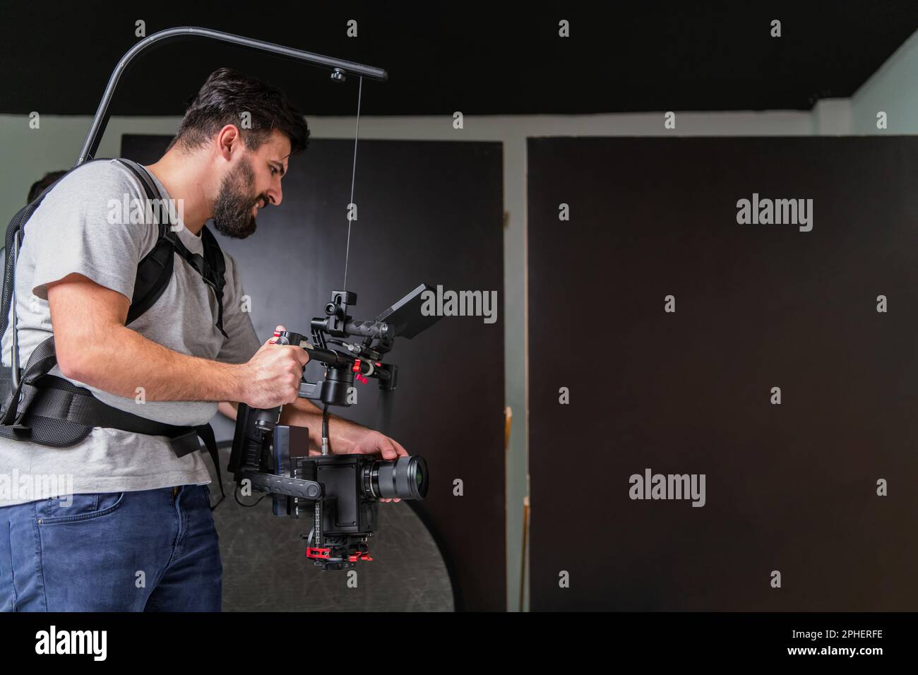 The cameraman in the studio using a professional camera with a ...