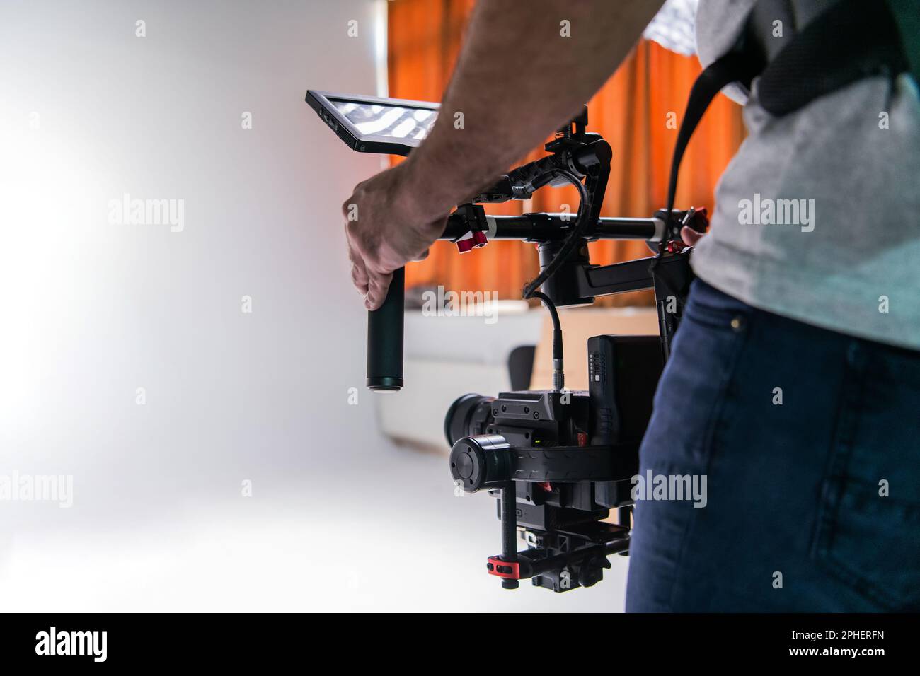 The cameraman in the studio using a professional camera with a ...