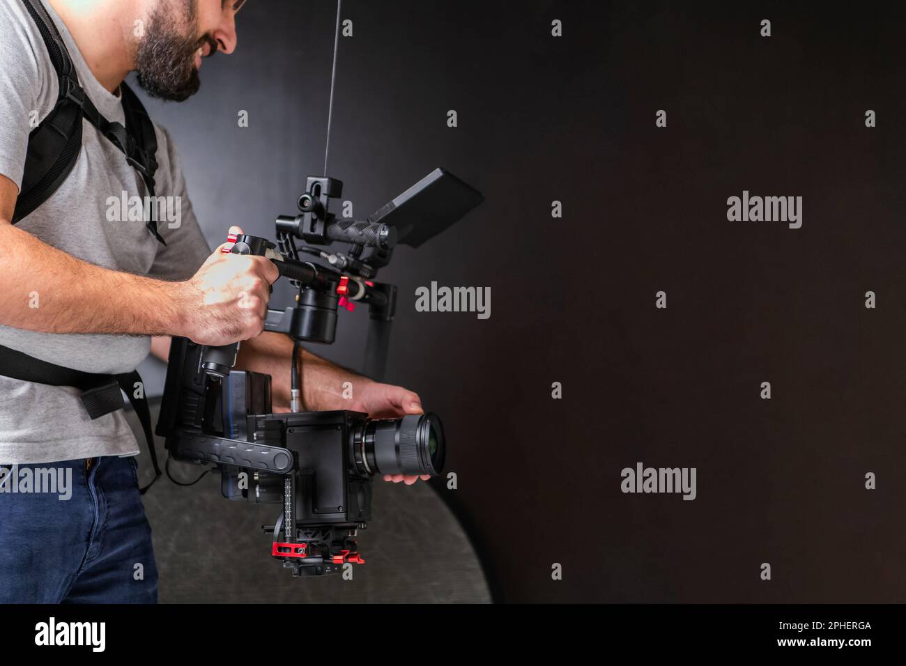 The cameraman in the studio using a professional camera with a ...