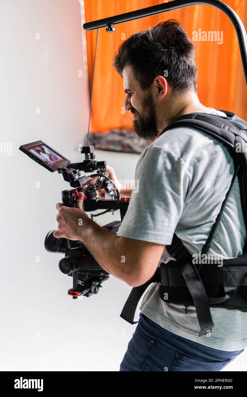 The cameraman in the studio using a professional camera with a ...