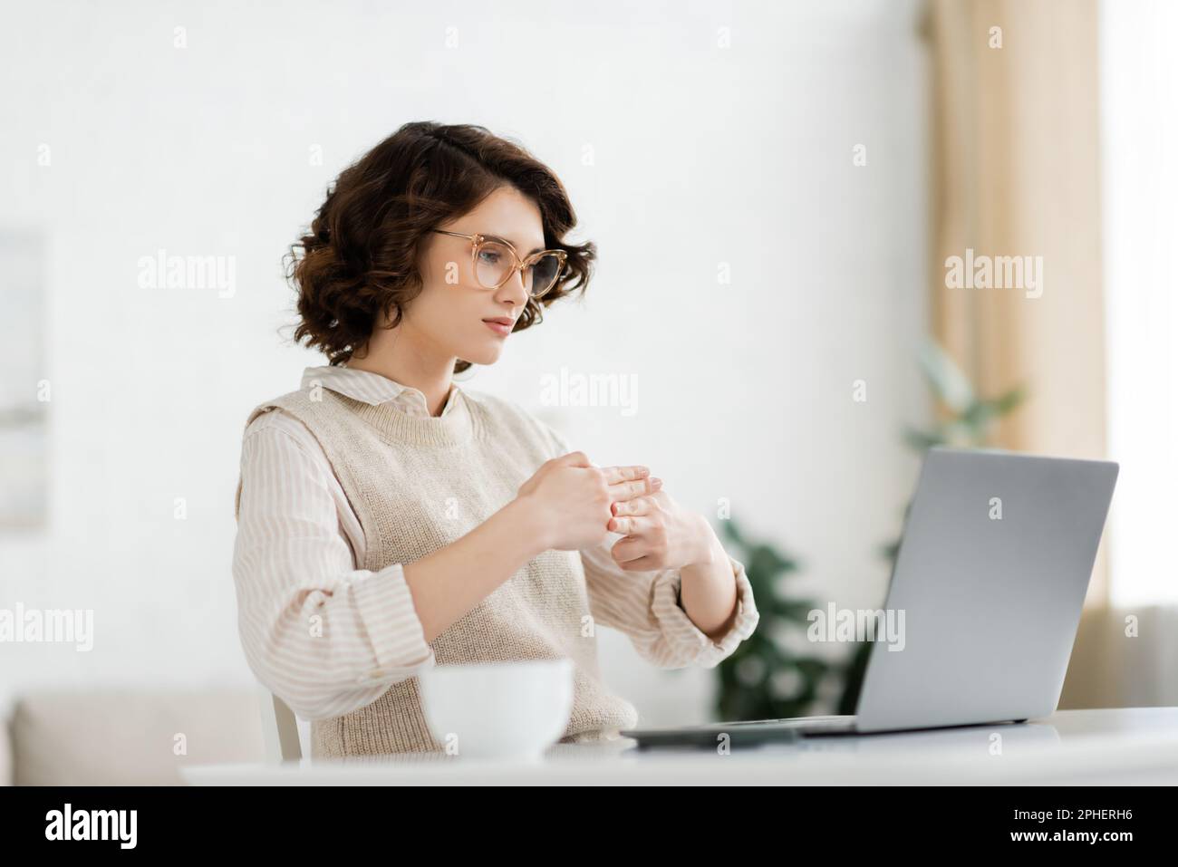 young teacher showing two handed gesture while teaching sign language ...