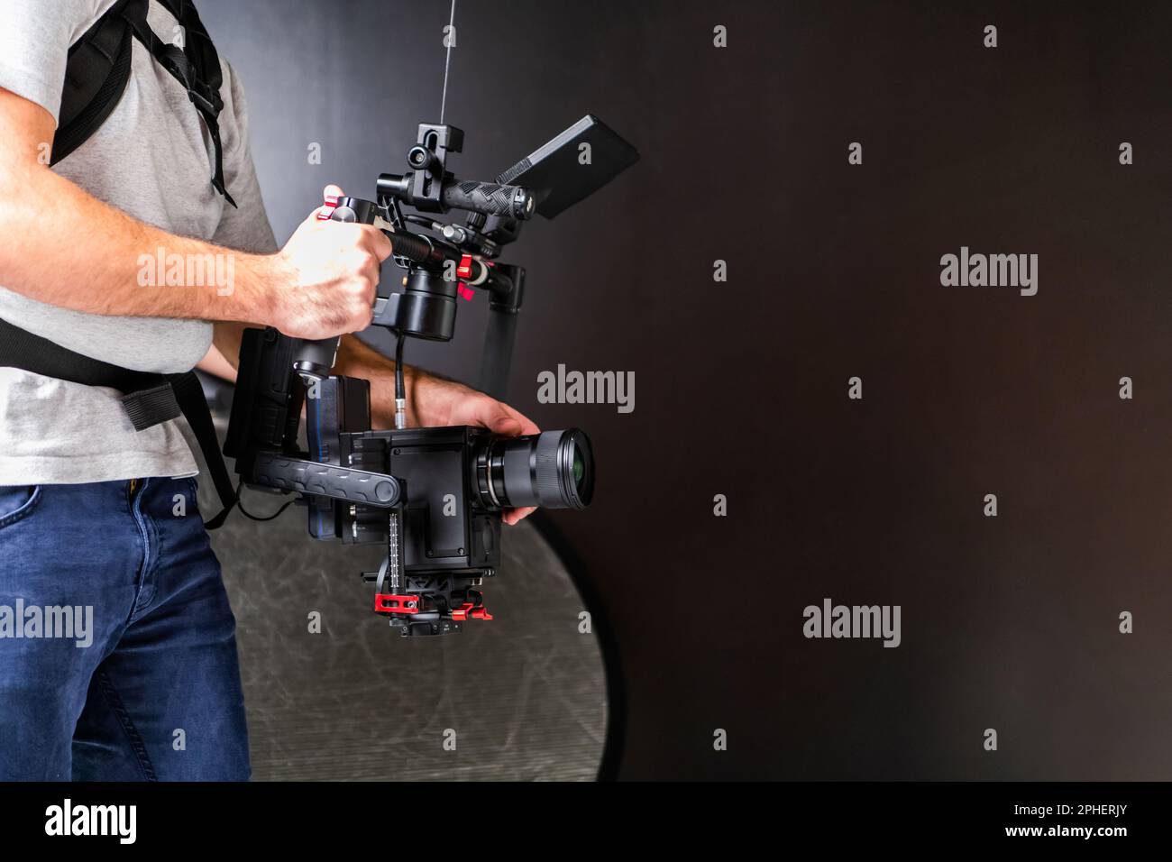 The cameraman in the studio using a professional camera with a ...