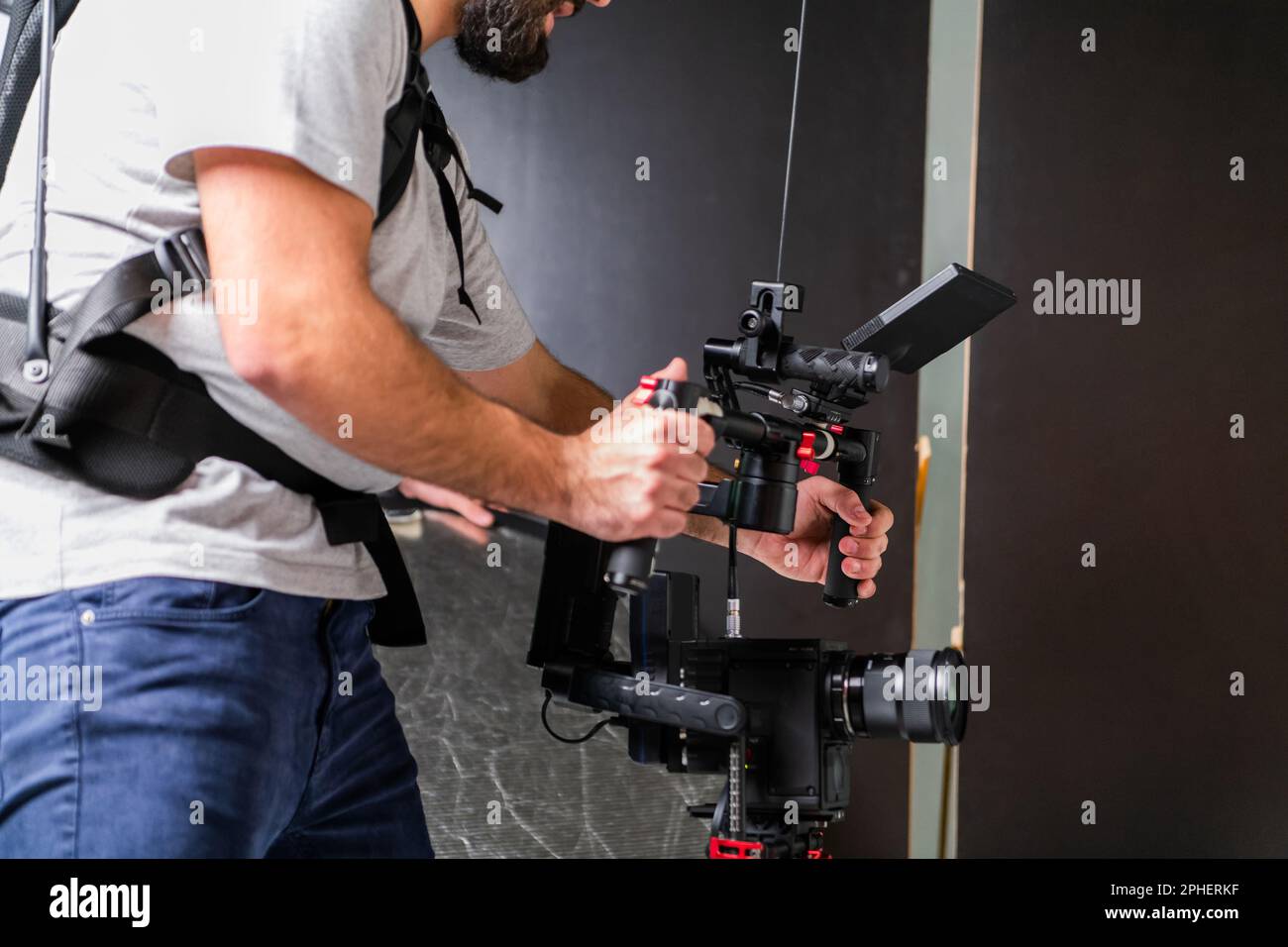 The cameraman in the studio using a professional camera with a ...