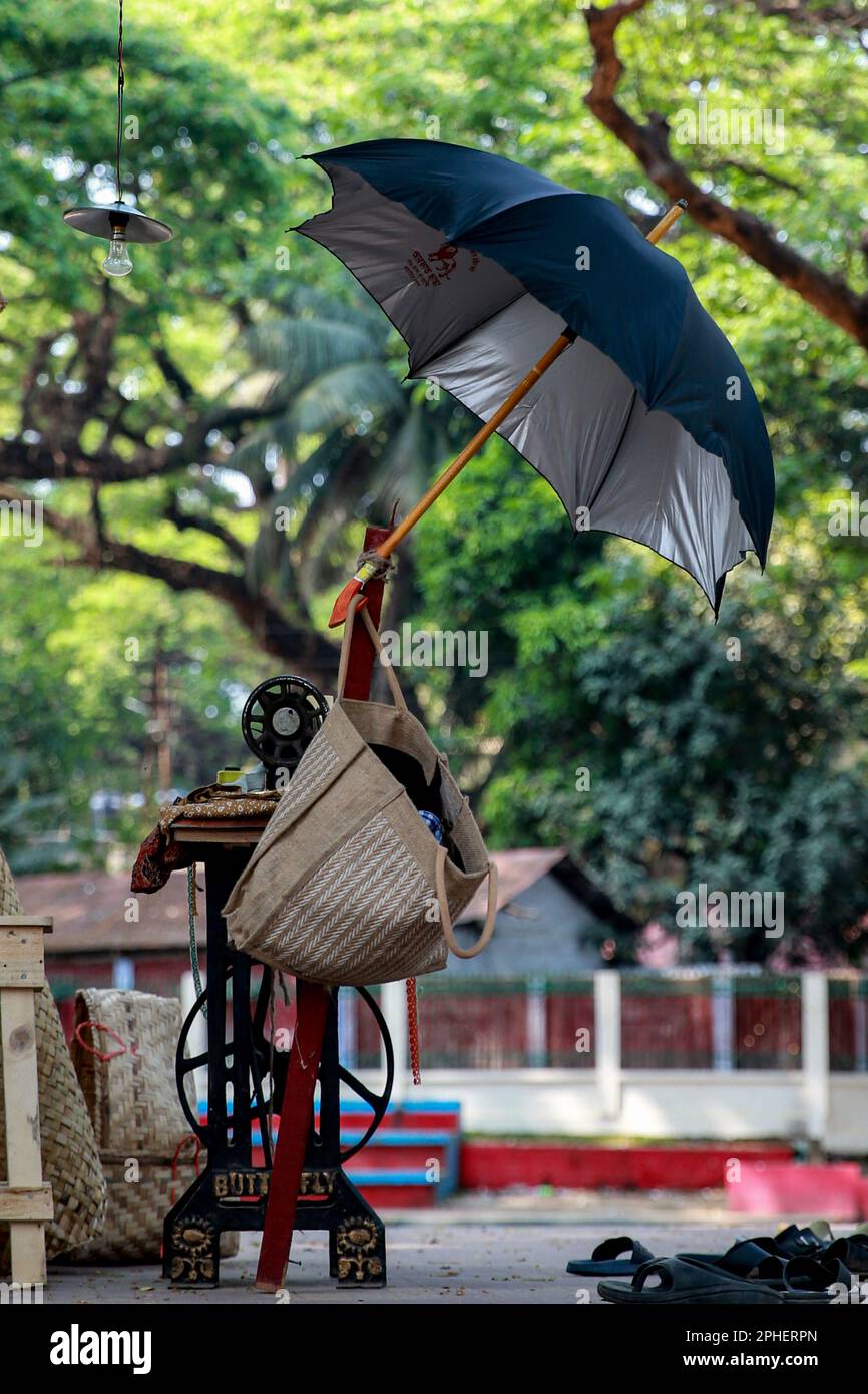 A tailor's sewing machine under a tree, a typical image of Bangladesh's ...