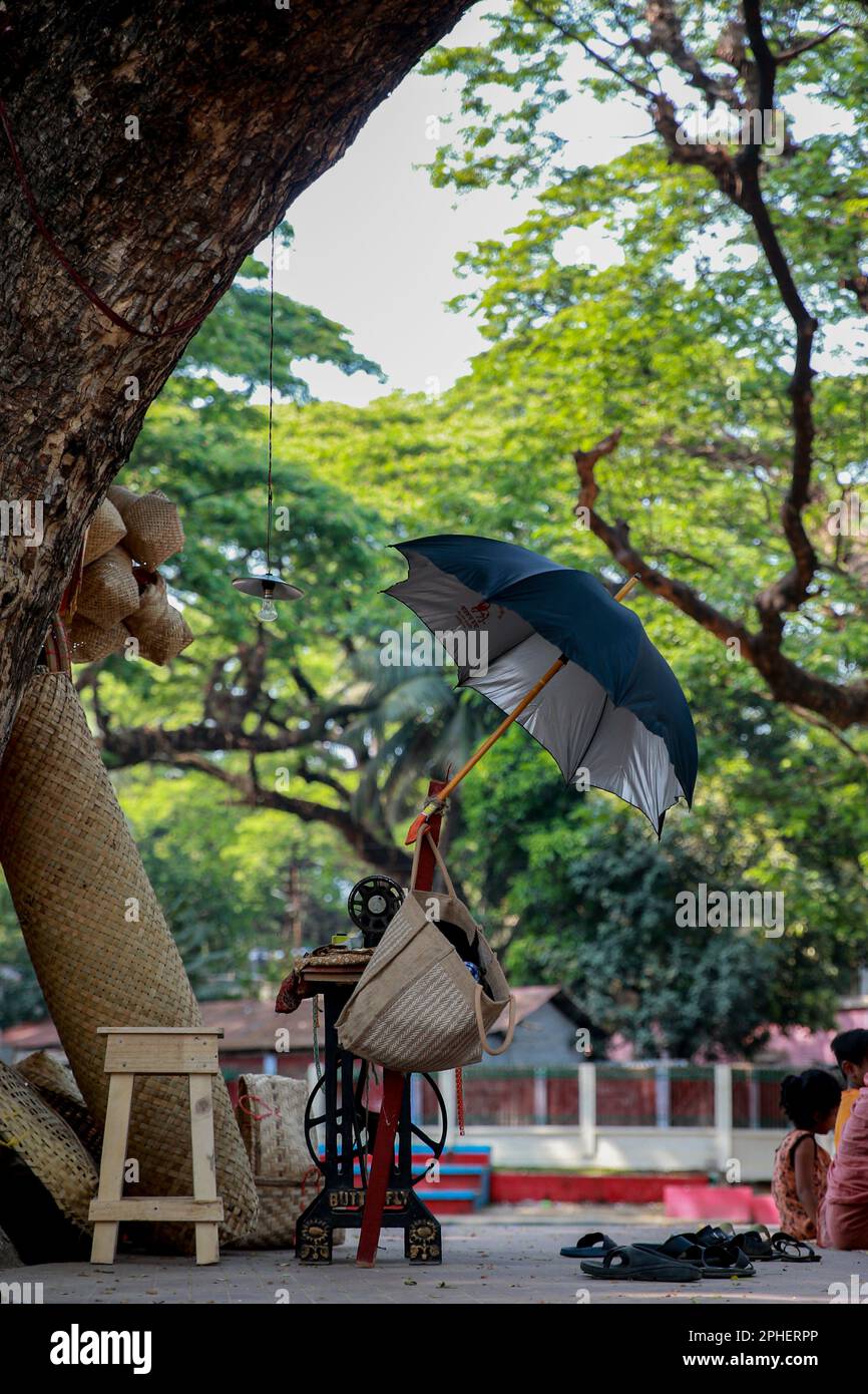 A tailor's sewing machine under a tree, a typical image of Bangladesh's ...