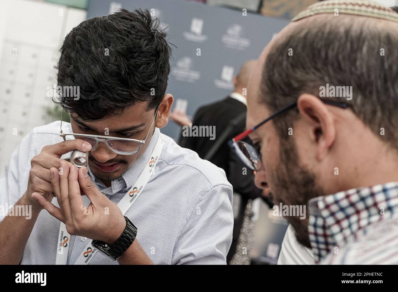 Ramat Gan, Israel. 28th Mar, 2023. A man studies a diamond at an ...