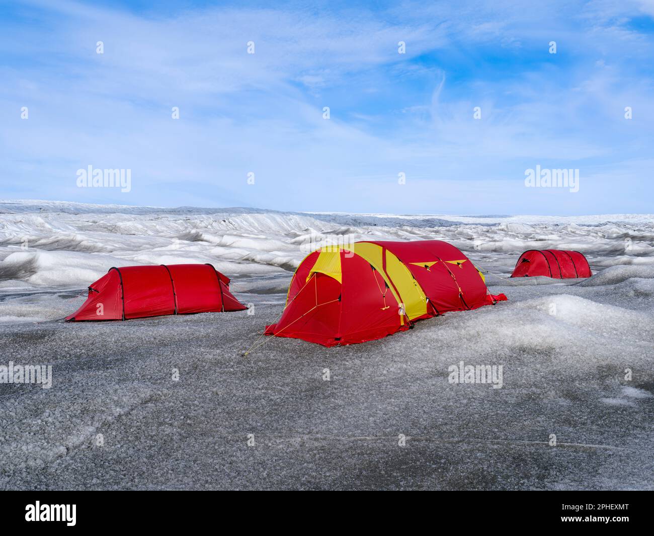 Camp with tents on the ice sheet. The brown sediment on the ice is ...