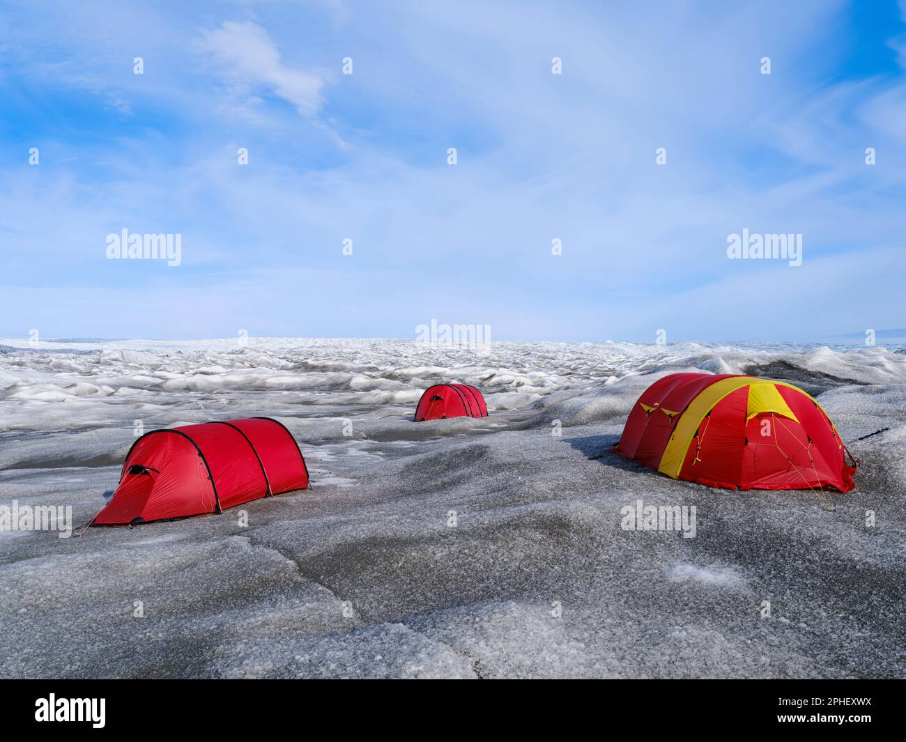 Camp with tents on the ice sheet. The brown sediment on the ice is ...