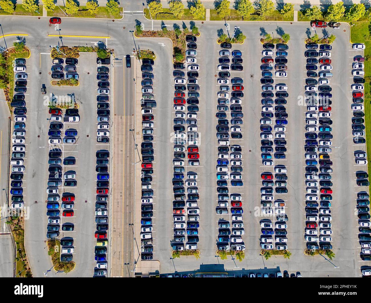 An aerial shot of a large parking lot filled with neatly arranged rows ...