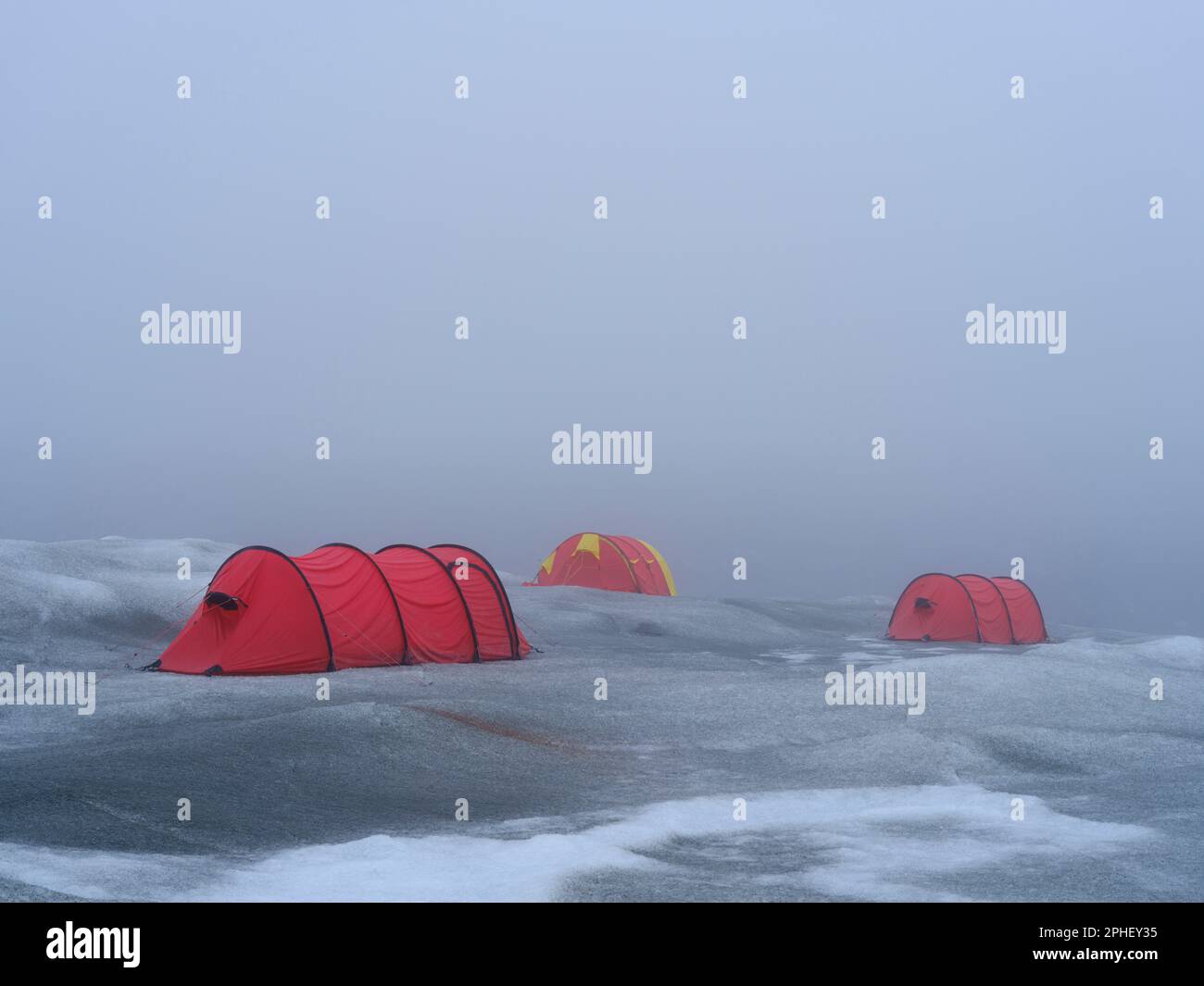 Camp with tents on the ice sheet. The brown sediment on the ice is ...