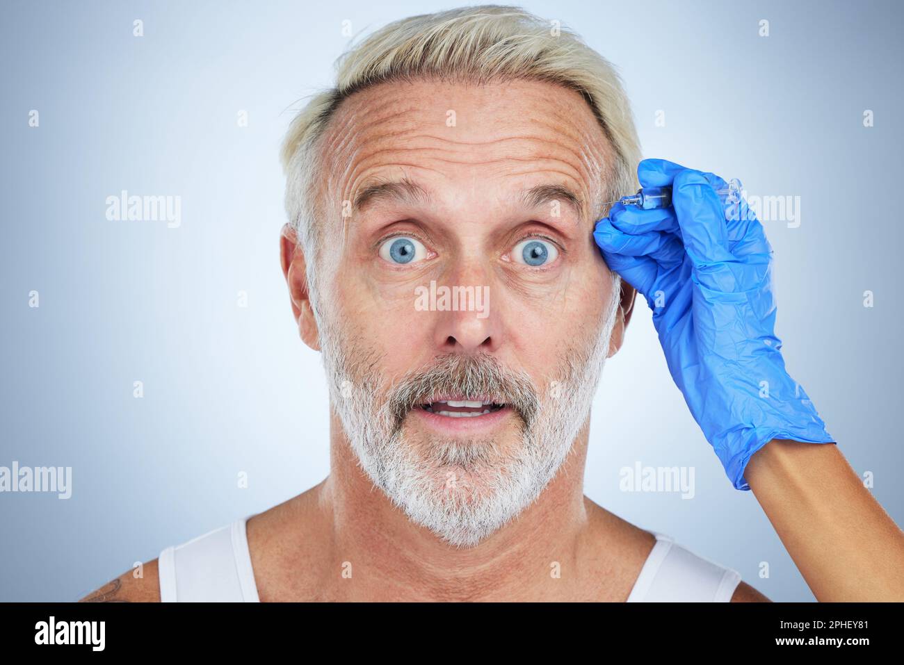 Syringe, portrait and surprise man of a senior face in a studio doing ...