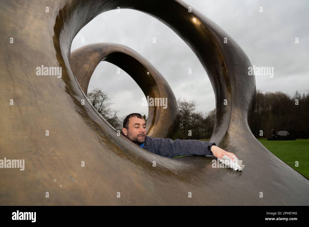 Sculpture technician Dai Roberts clean and dries the bronze sculpture ...