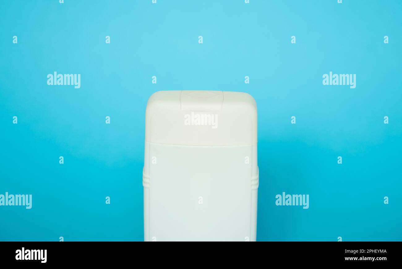 White square bottle for liquid soap, shampoo, gel on blue background ...