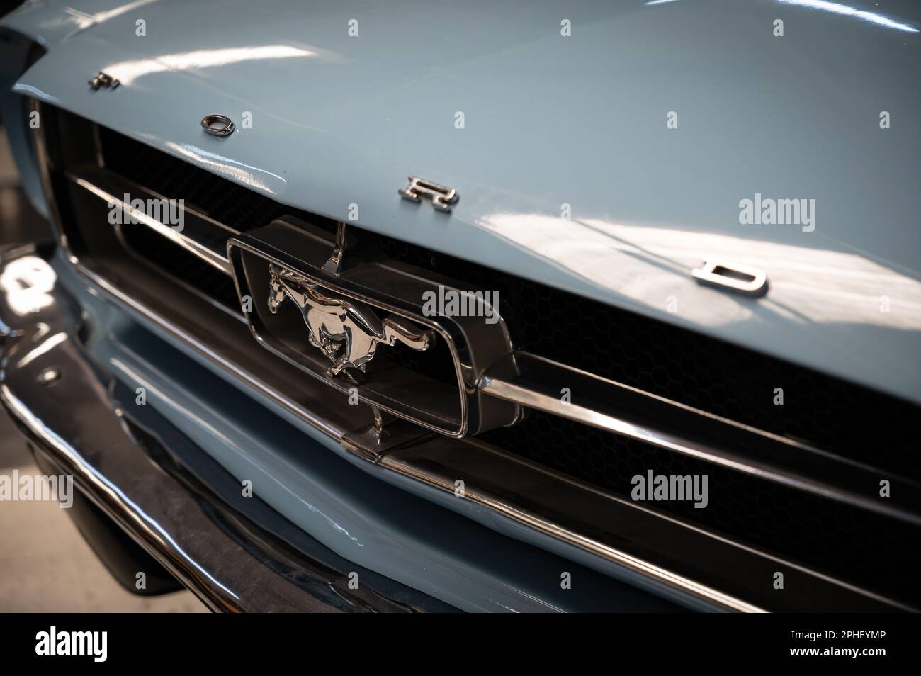 Grille detail with the logo of a classic blue Ford Mustang from 1965 ...