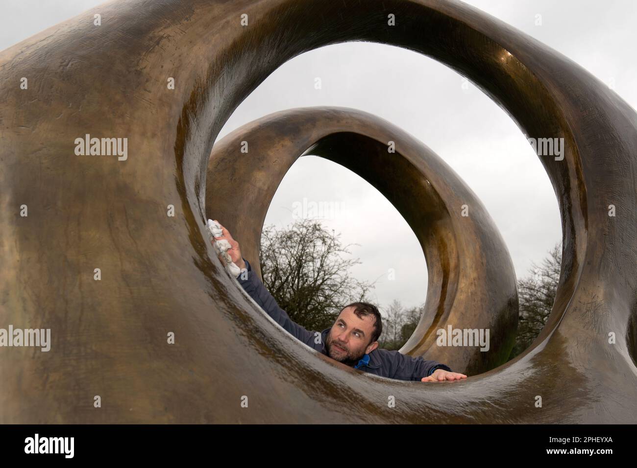Sculpture technician Dai Roberts clean and dries the bronze sculpture ...