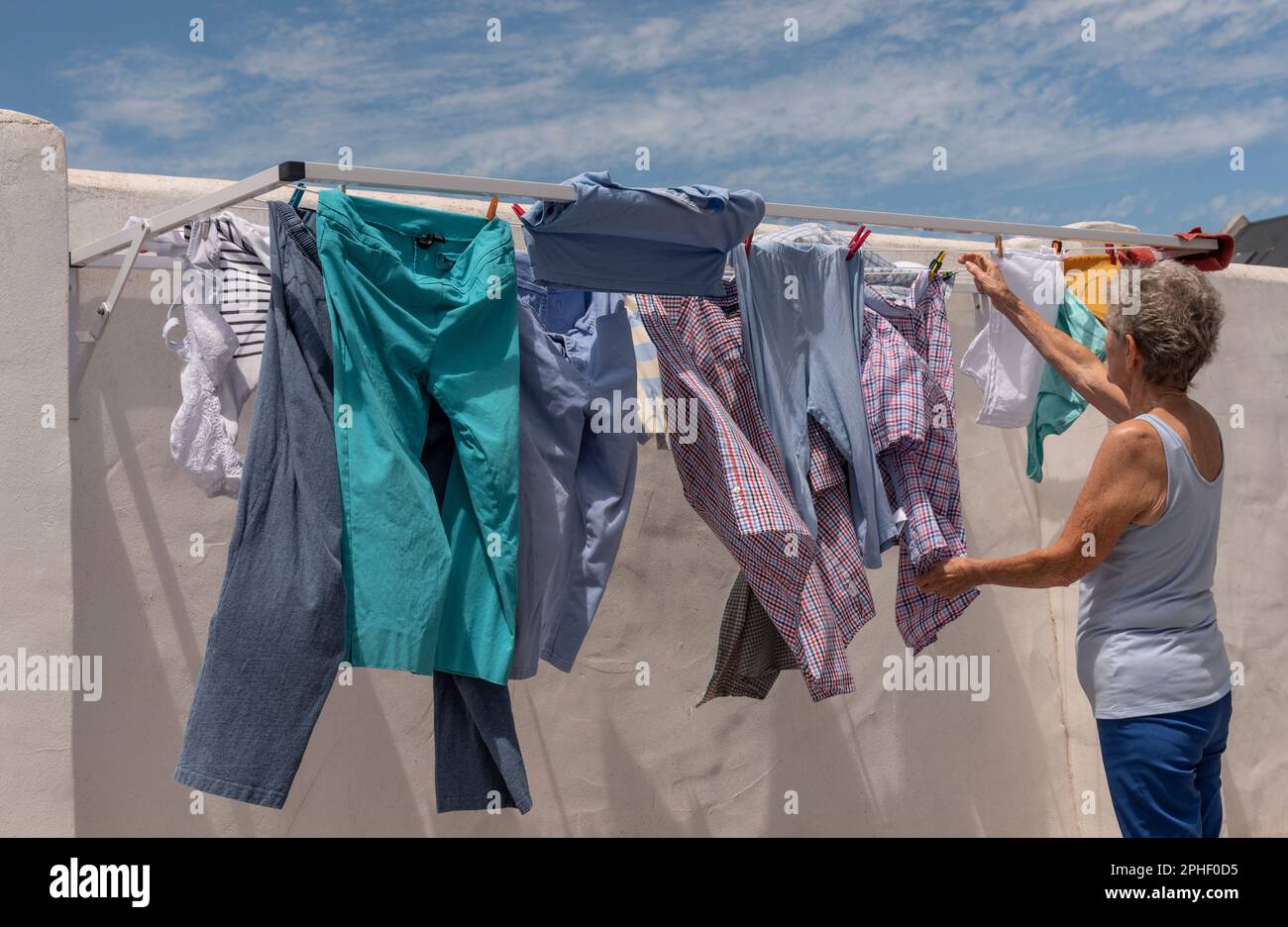 Langebaan, South Africa. 2023. Elderly woman hanging out the washing on ...