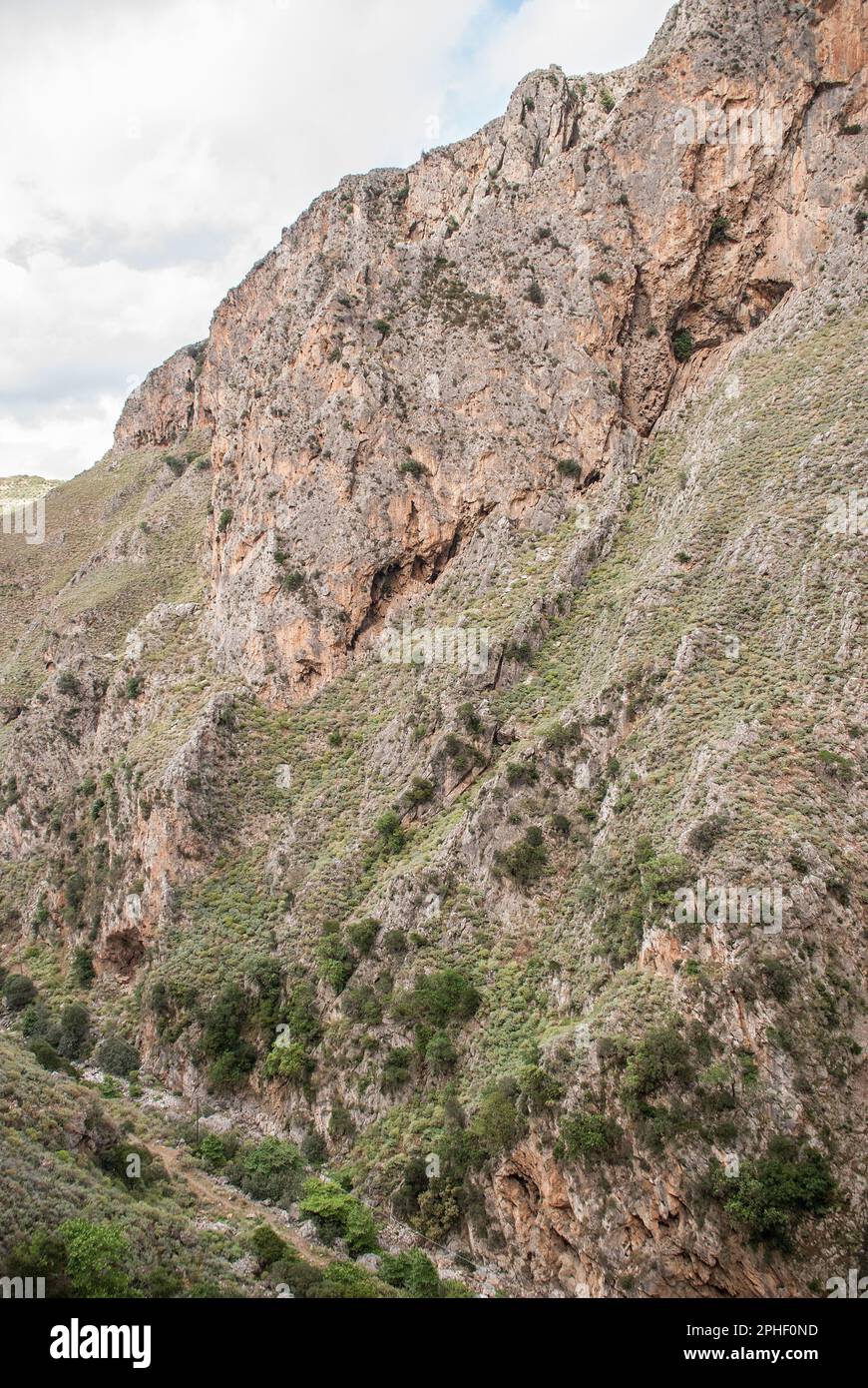 Gorge walking in Crete along the bottom of high-sided canyon with ...