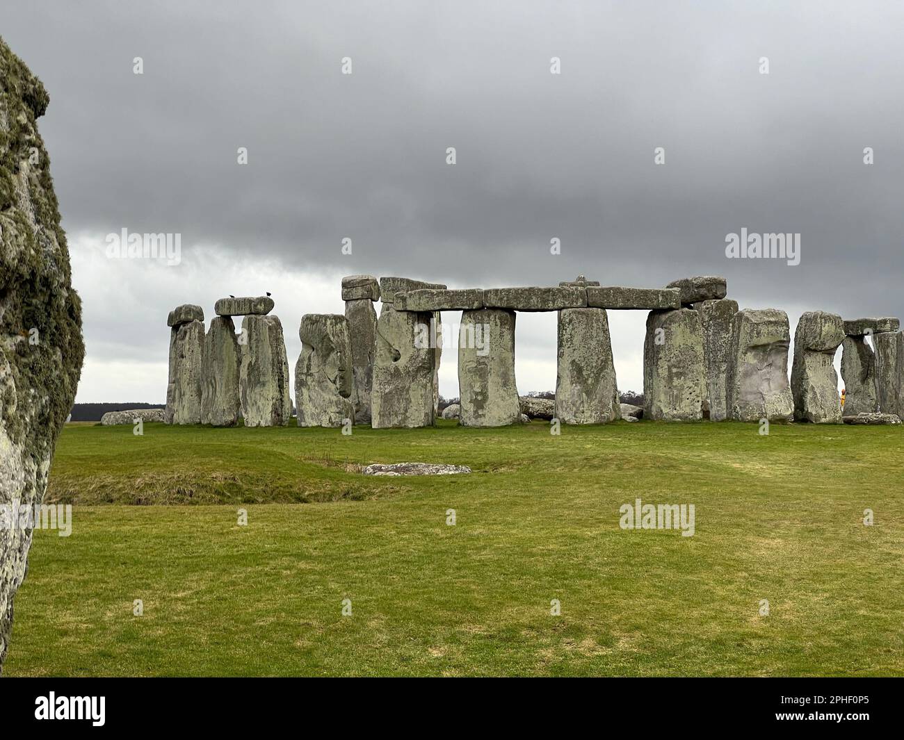 An ancient prehistoric stone monument Stonehenge against the cloudy sky ...