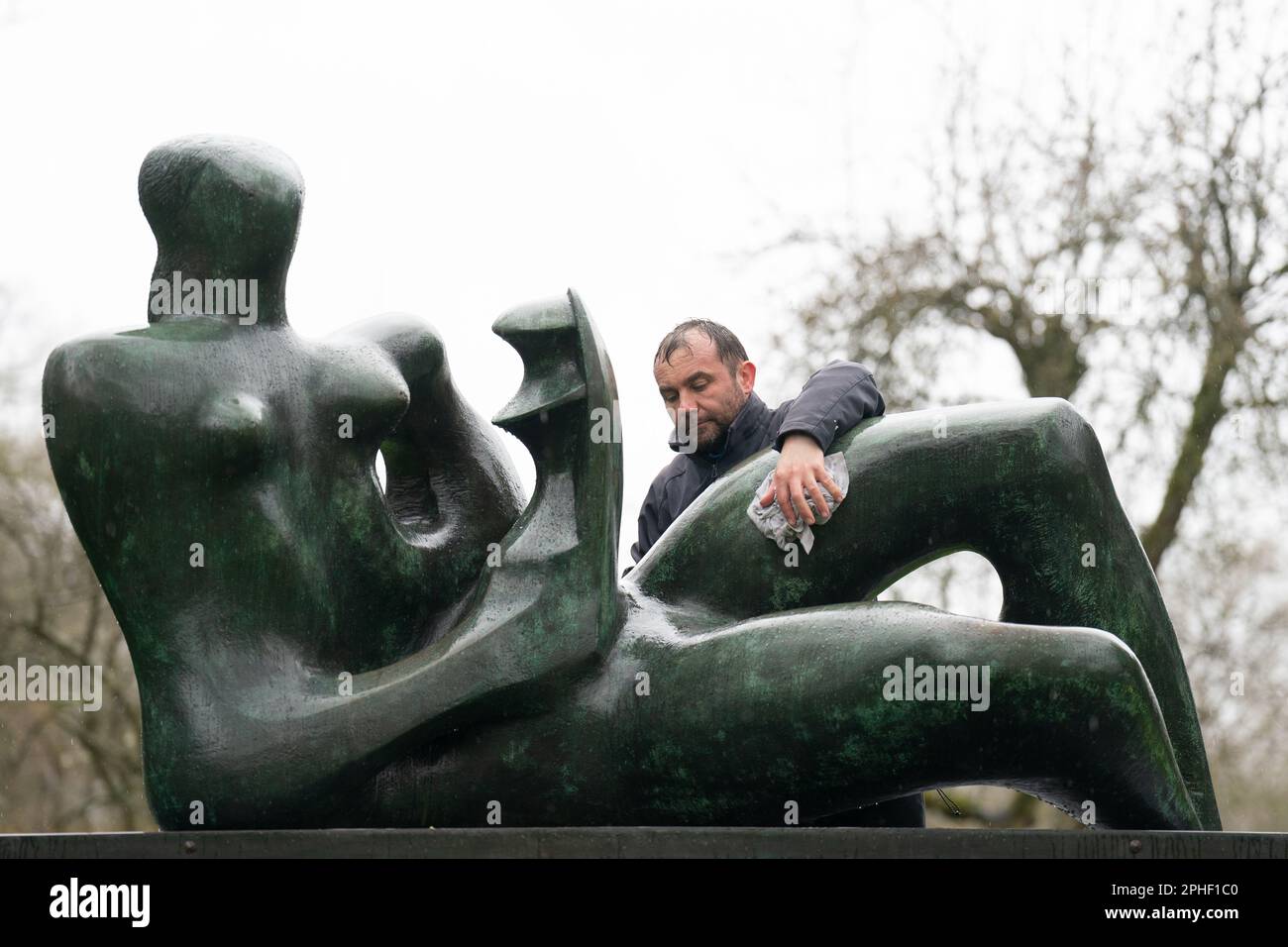 Sculpture technician Dai Roberts clean and dries the bronze sculpture ...