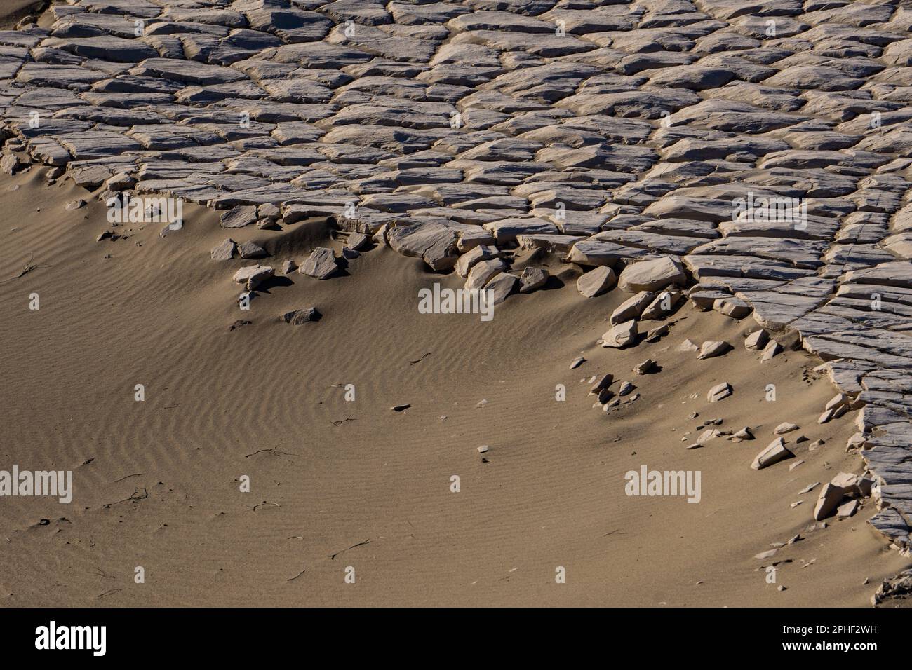 A scenic beachscape featuring an impressive wave-like formation made of ...