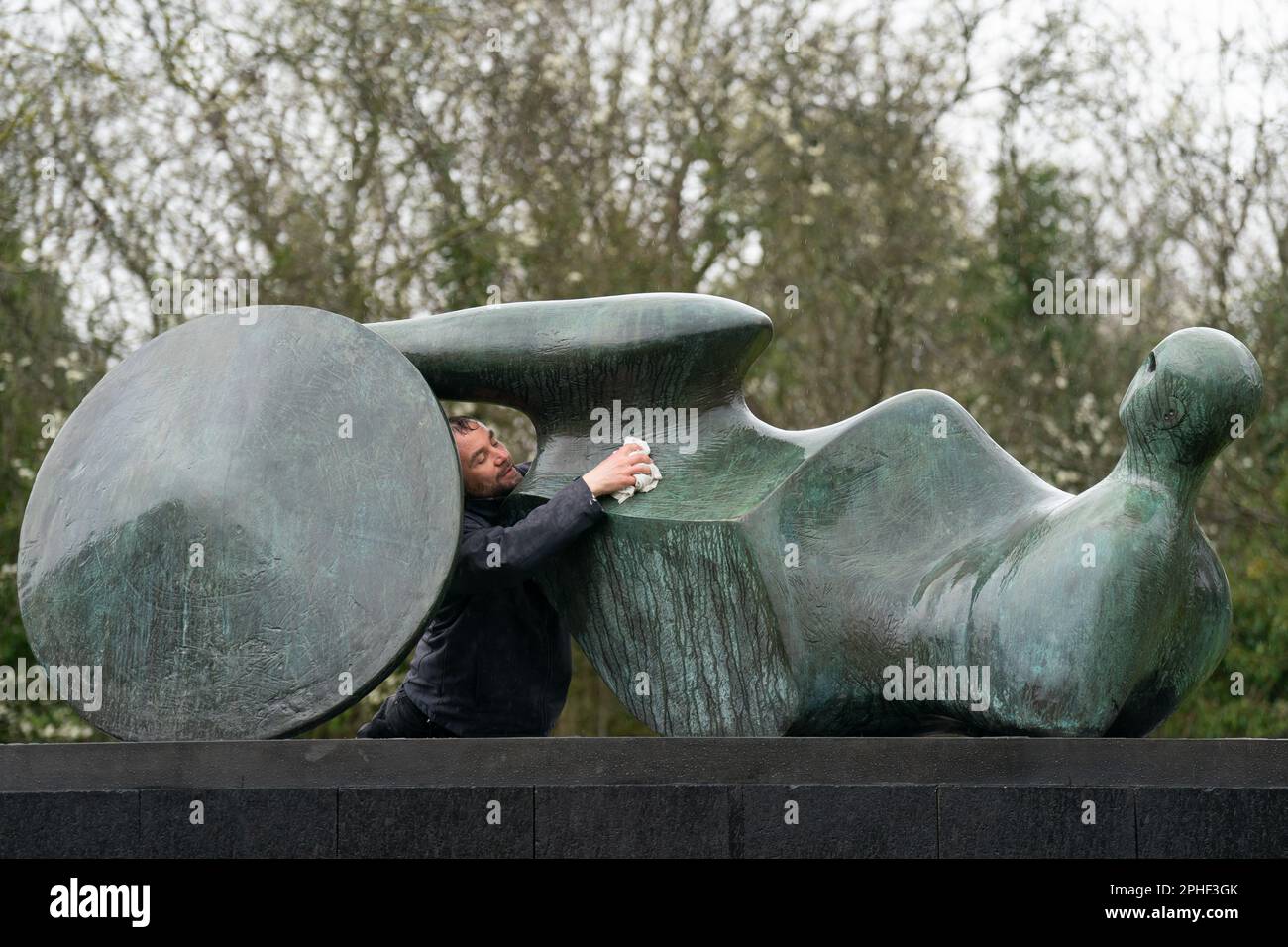 Sculpture technician Dai Roberts cleans and dries the bronze sculpture ...